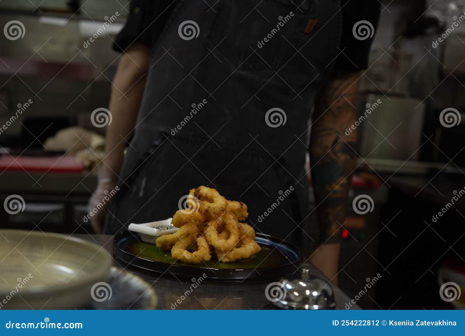 Chef Prepares Deep-fried Onion Rings in the Restaurant Kitchen. Stock ...
