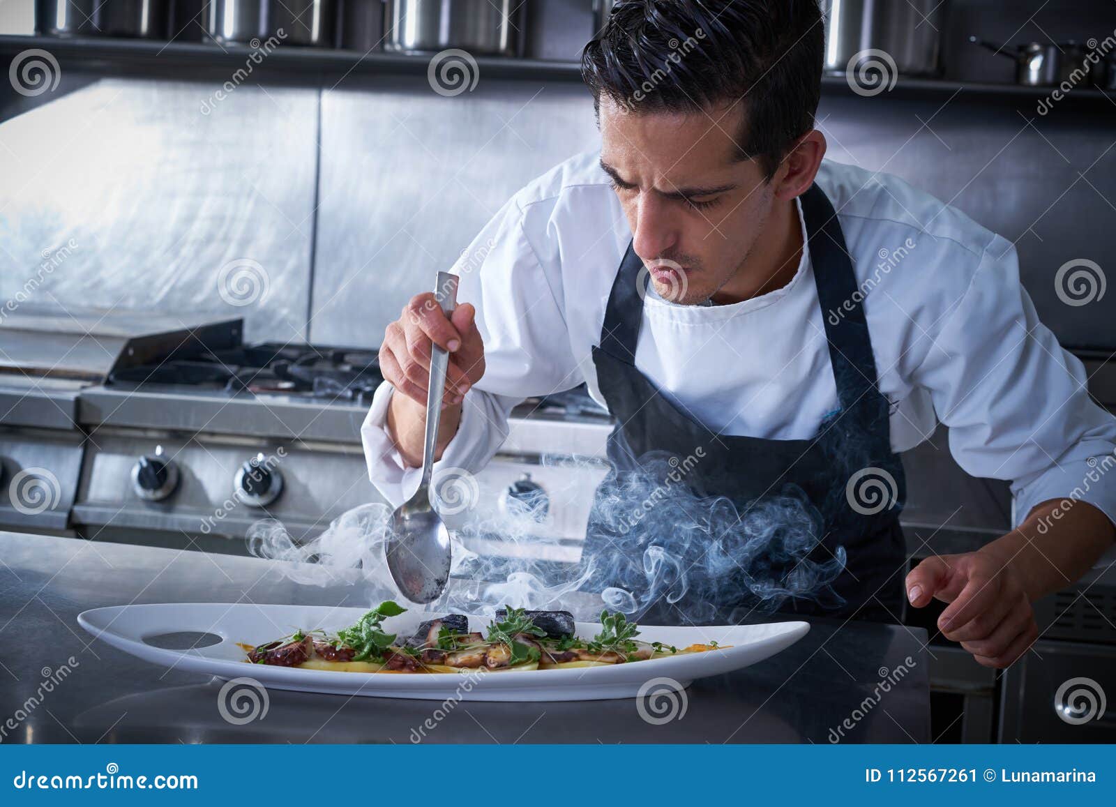 Chef Preparing Octopus in Kitchen with Smoke Stock Image - Image of ...