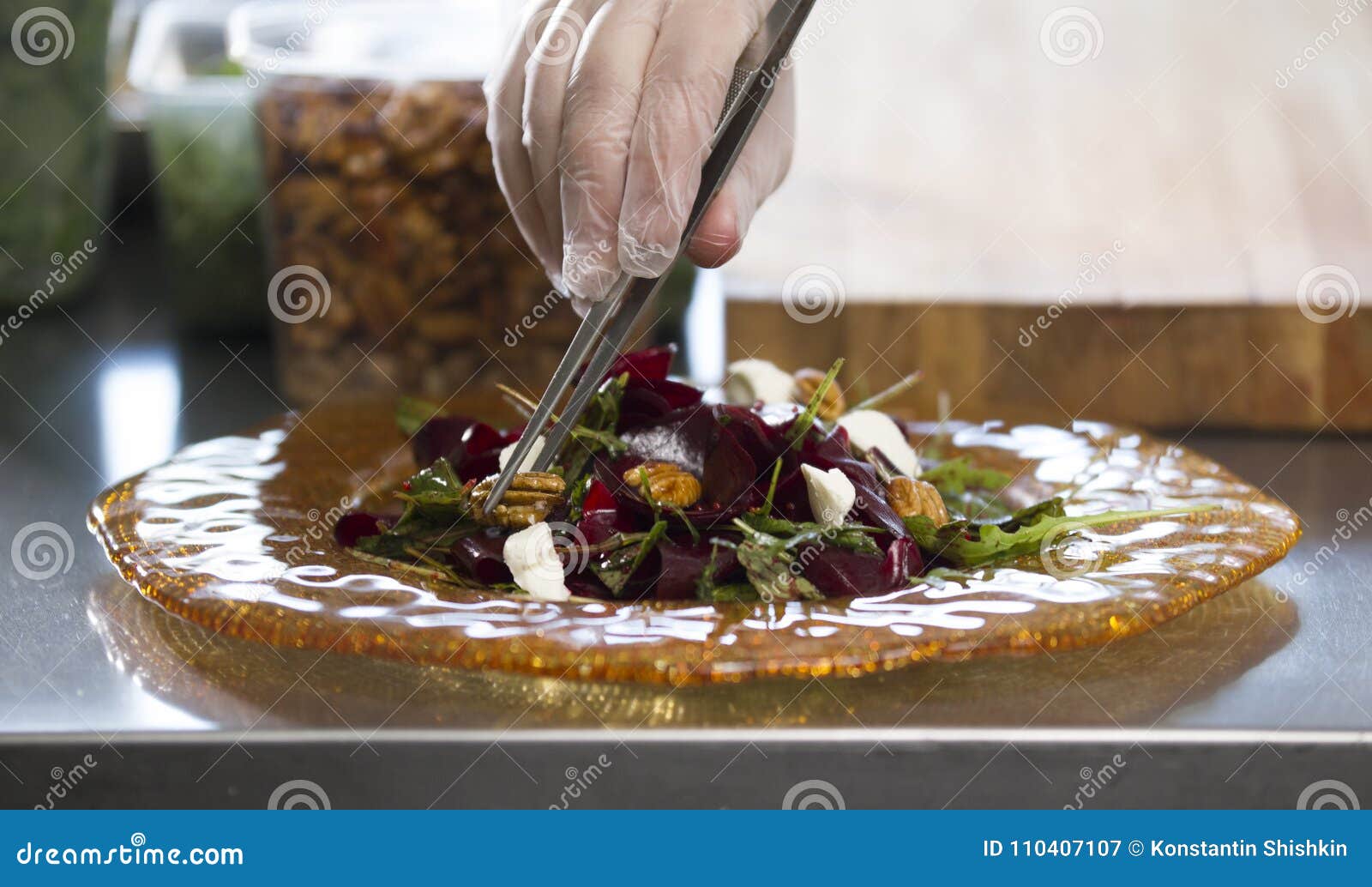Chef Preparing and Serving a Salad in the Kitchen of the Restaurant ...