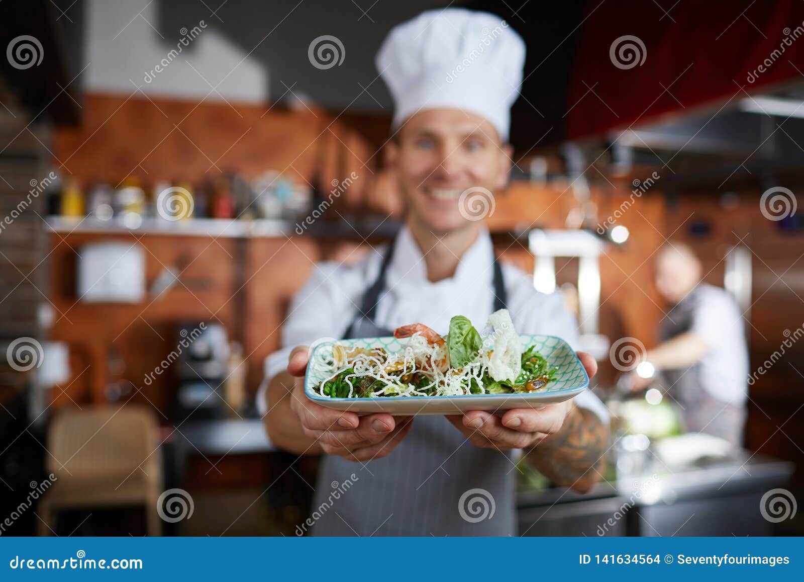 Chef Presenting Dish stock photo. Image of cook, apron - 141634564