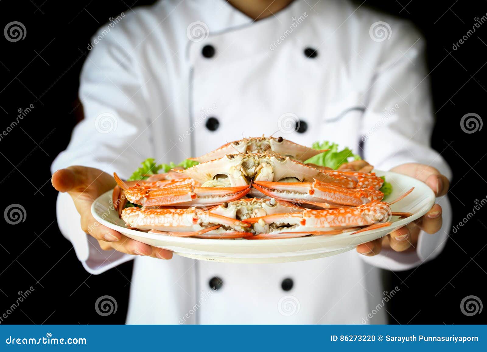 Chef Proudly Presenting Steamed Crabs on the Plate in Dark Dramatic ...