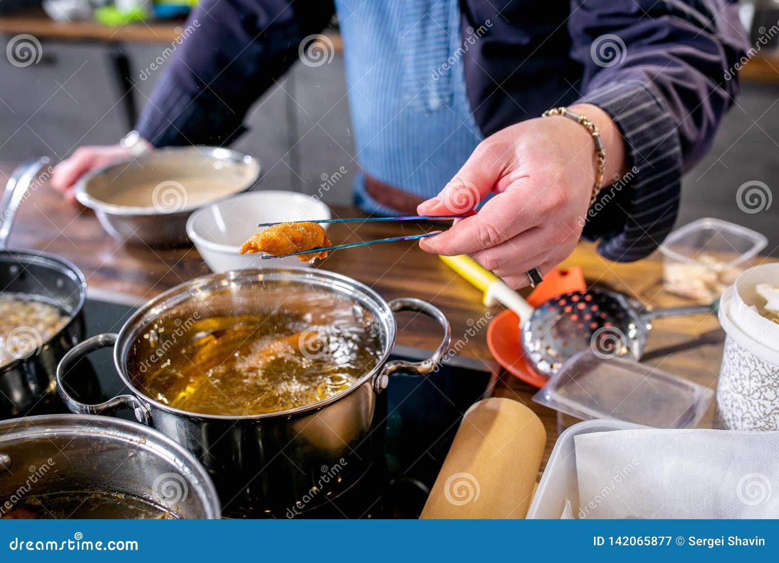 Chef Pulls Out Fried Fish Pieces in Batter. Master Class in the Kitchen ...