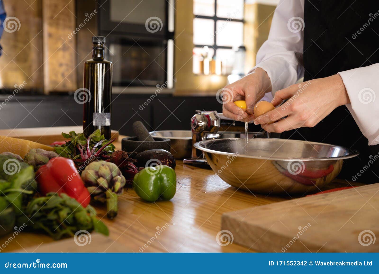Chef Putting an Egg in a Bowl Stock Photo - Image of olive, counter ...
