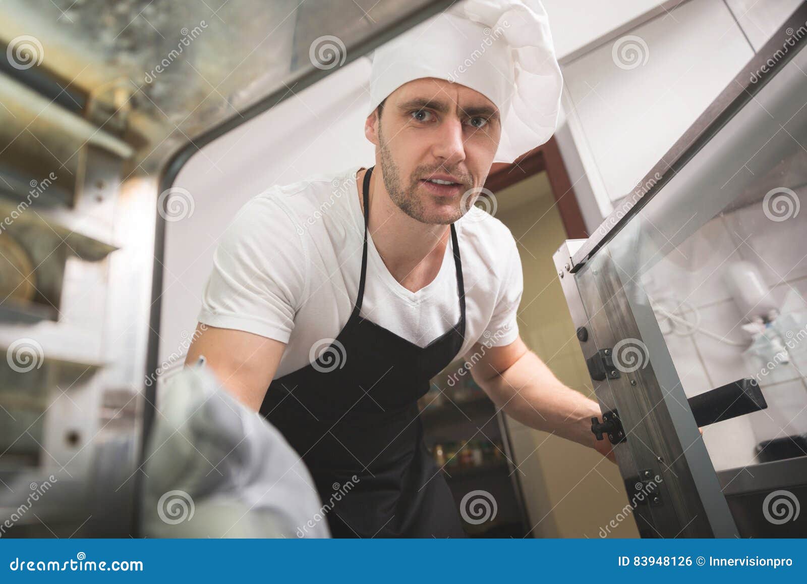 Chef Putting Food Out from Oven Stock Photo - Image of inside, male ...