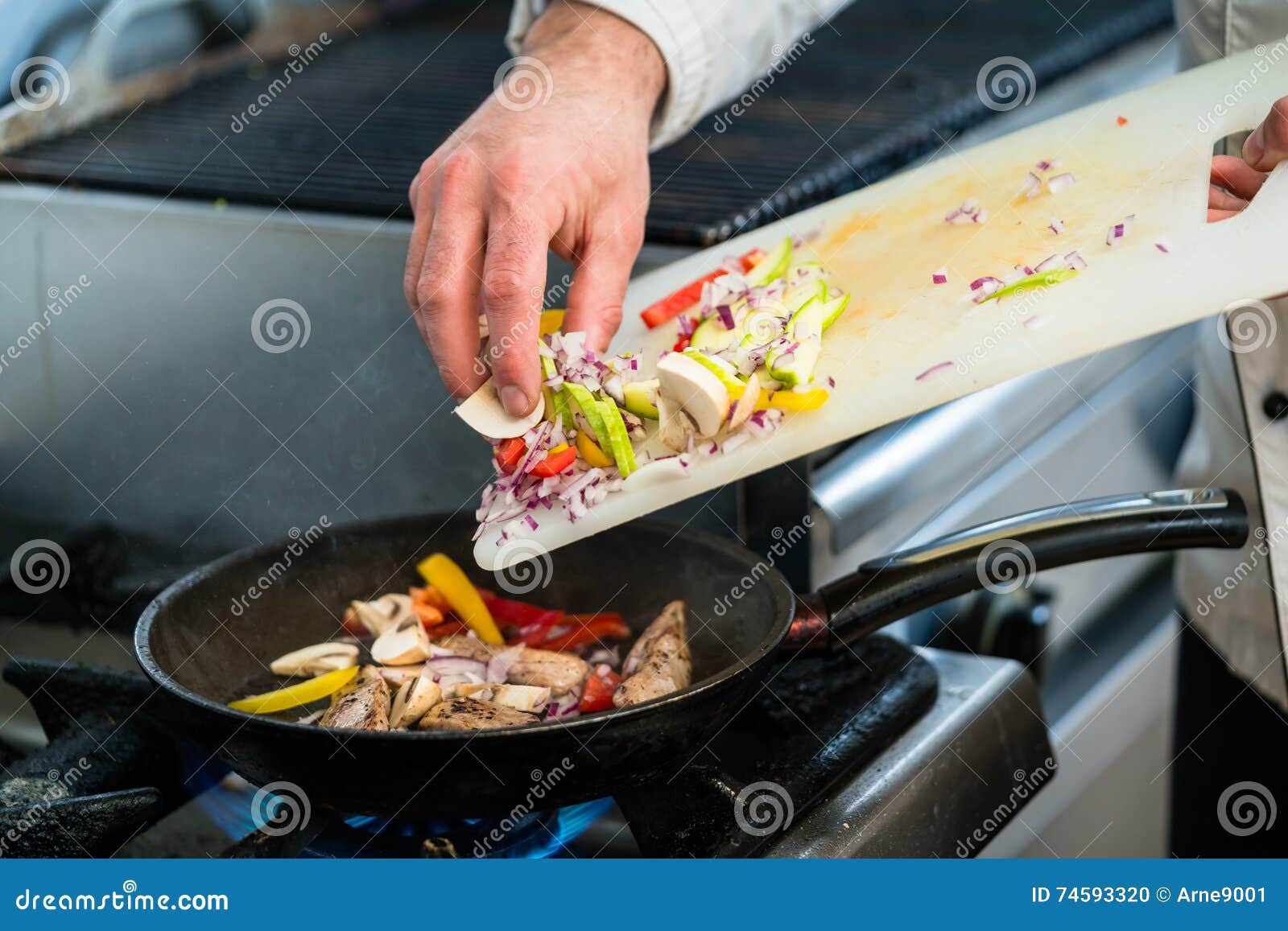 Chef Putting Ingredients To Pan in Restaurant Kitchen Stock Photo ...