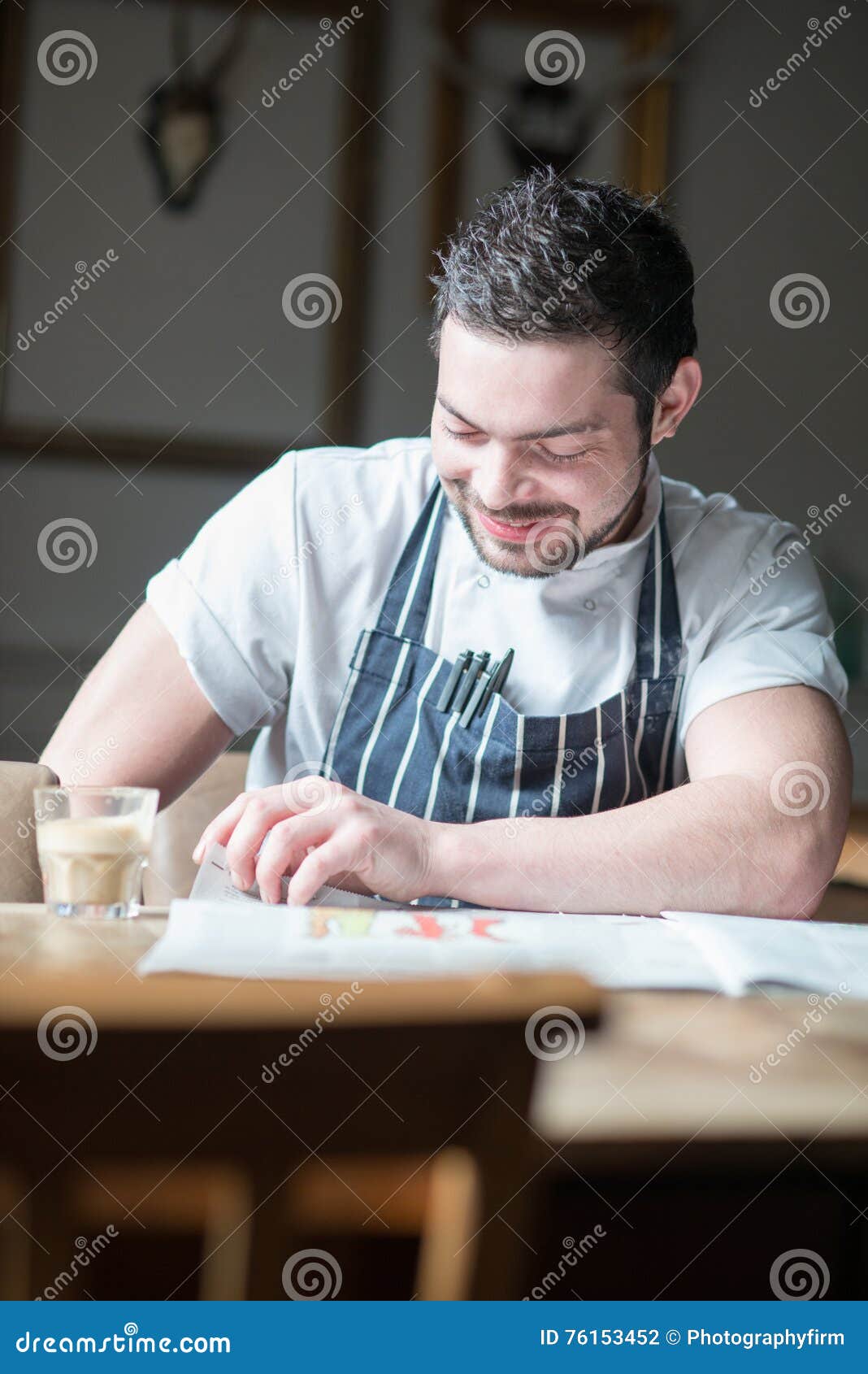 Chef reading a newspaper stock photo. Image of business - 76153452