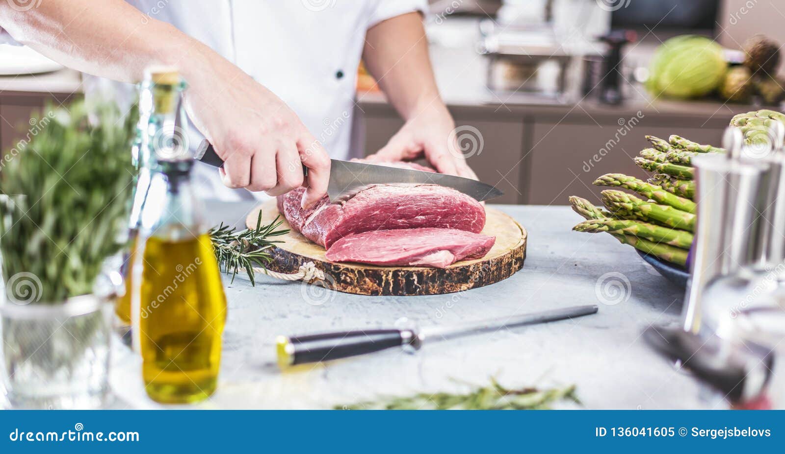 Chef in Restaurant Kitchen Cooking,he is Cutting Meat or Steak Stock ...