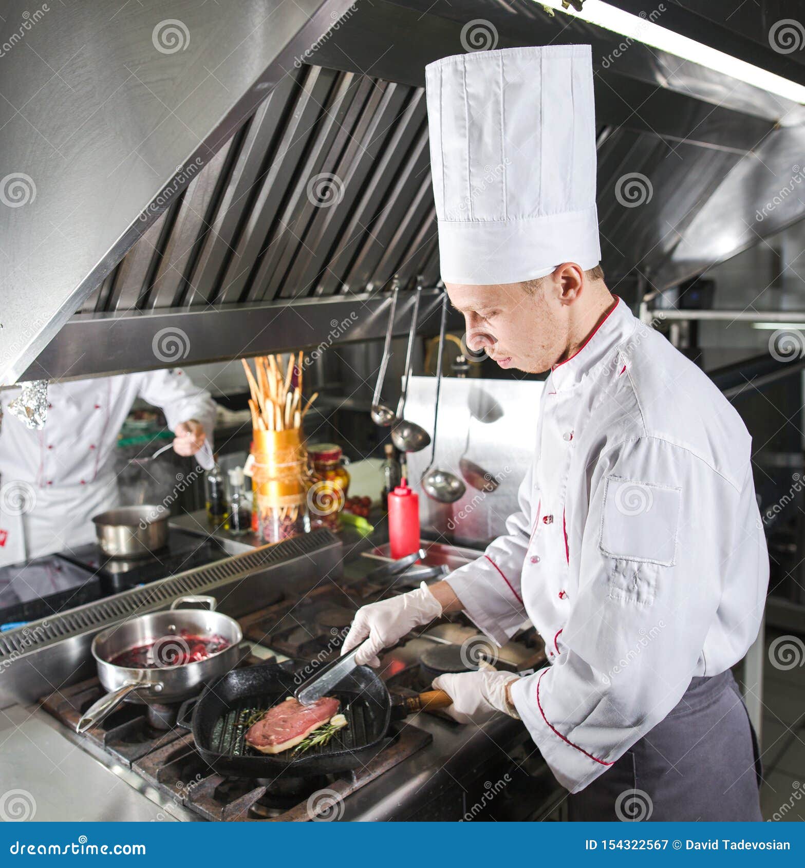 Chef in Restaurant Kitchen at Stove with Pan, Cooking. Stock Image ...