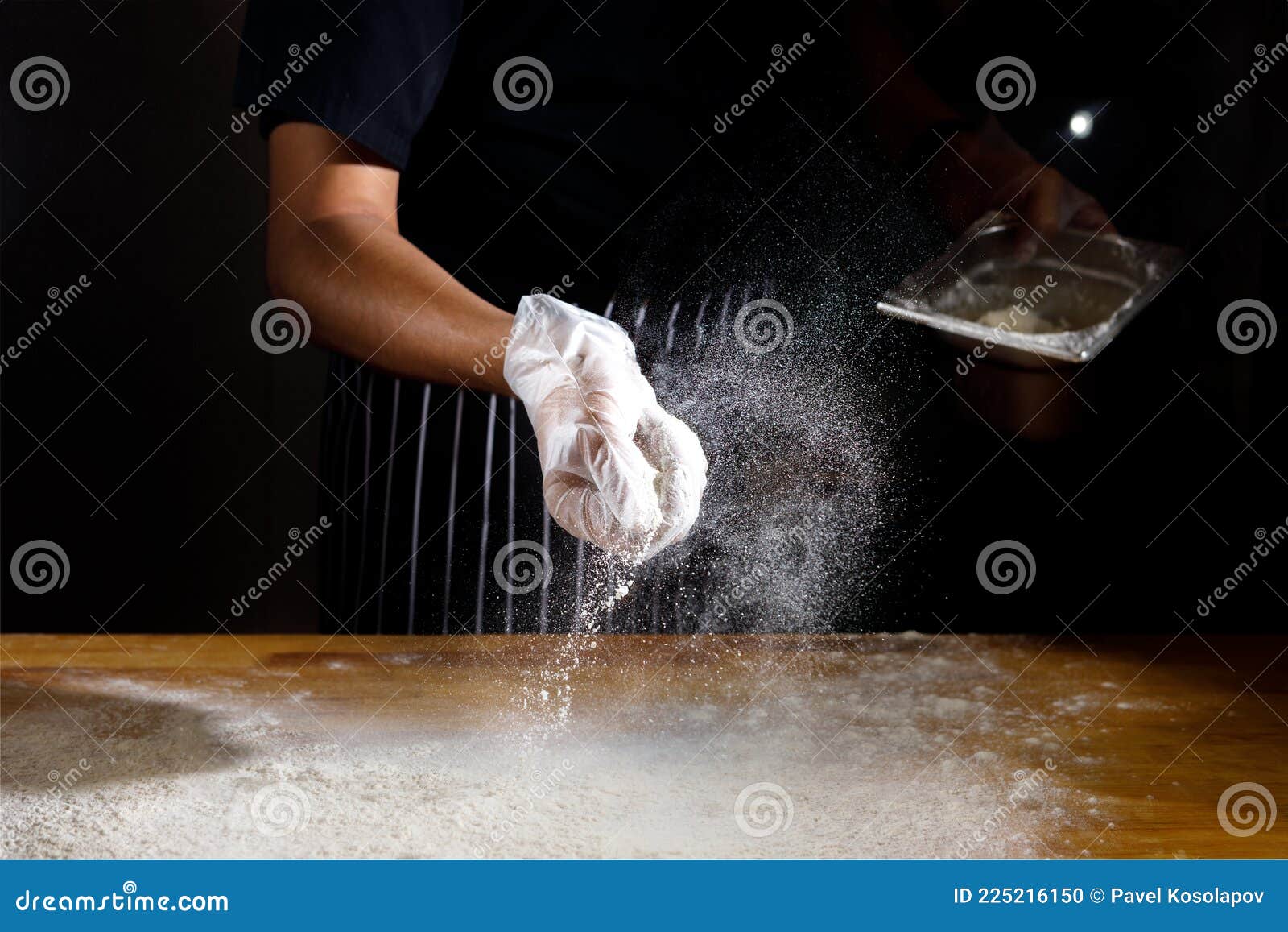 The Chef of the Restaurant Sprinkles Wheat Flour on the Table Stock ...