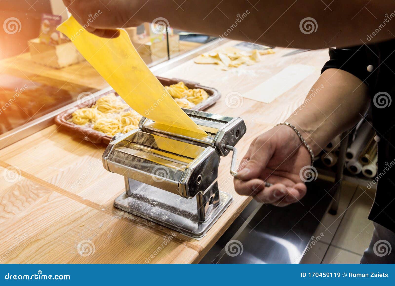 Chef Rolling Dough with a Pasta Machine. Pasta Maker Machine Stock ...
