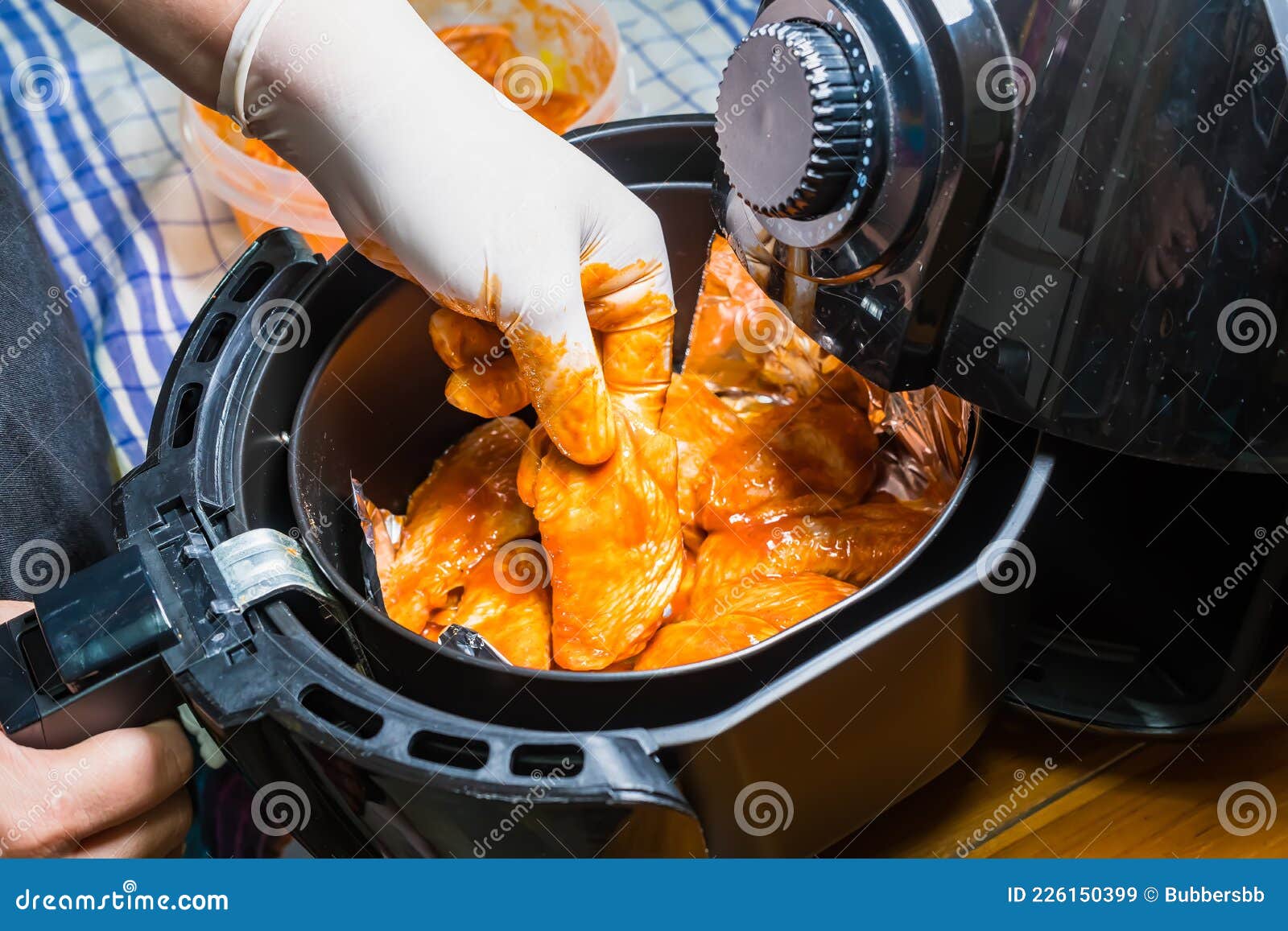 The Chef`s Hands are Slathering the Chicken Wings in the BBQ Sauce ...
