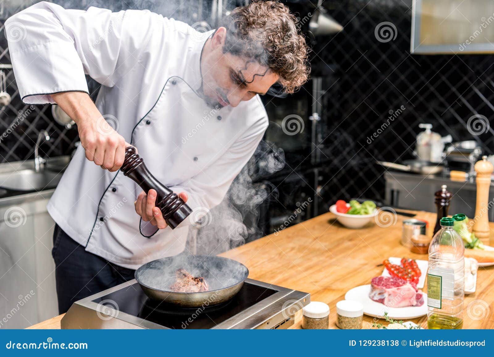 Chef seasoning frying meat stock photo. Image of caucasian - 129238138