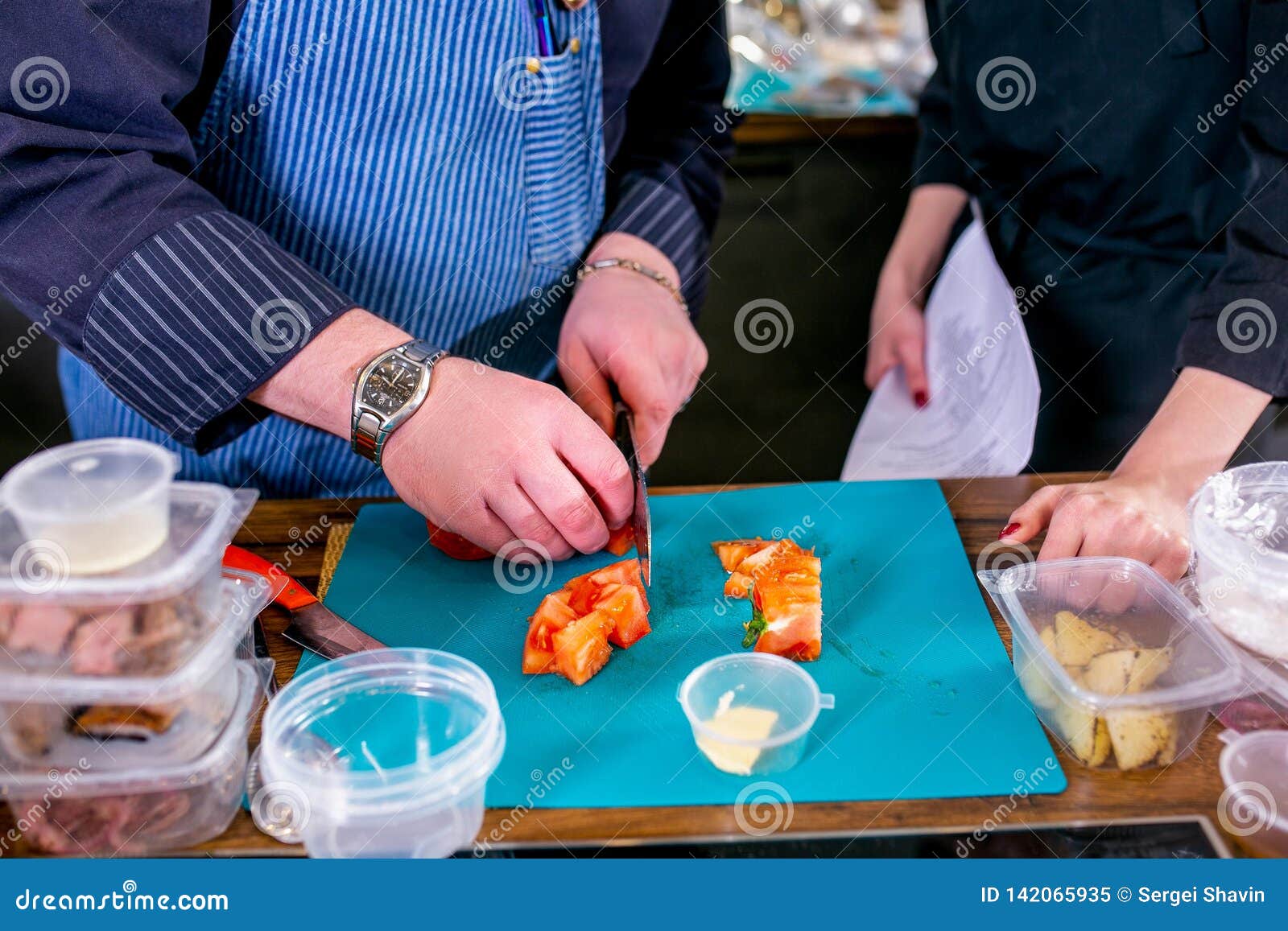 Chef Showing Student How To Cut a Tomato. Master Class in the Kitchen ...