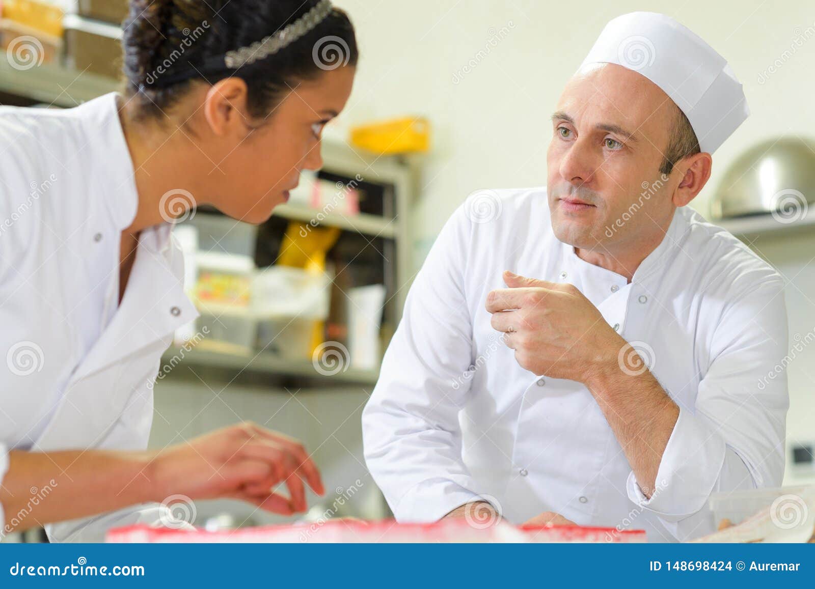 Chef Showing Talking To Female Trainee Stock Photo - Image of culinary ...