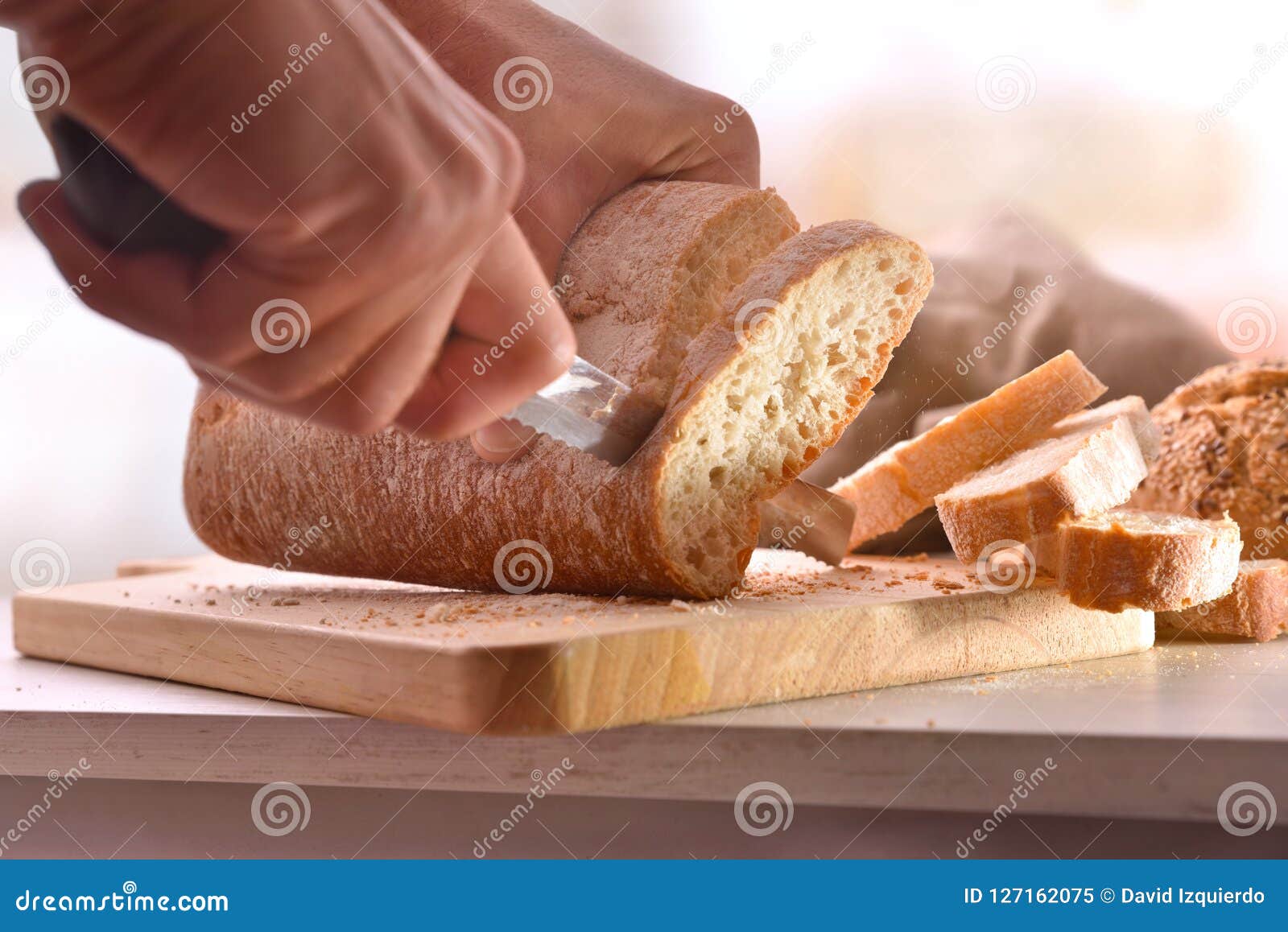 Chef Slicing Bread in Slices on a Cutting Board Stock Image - Image of ...