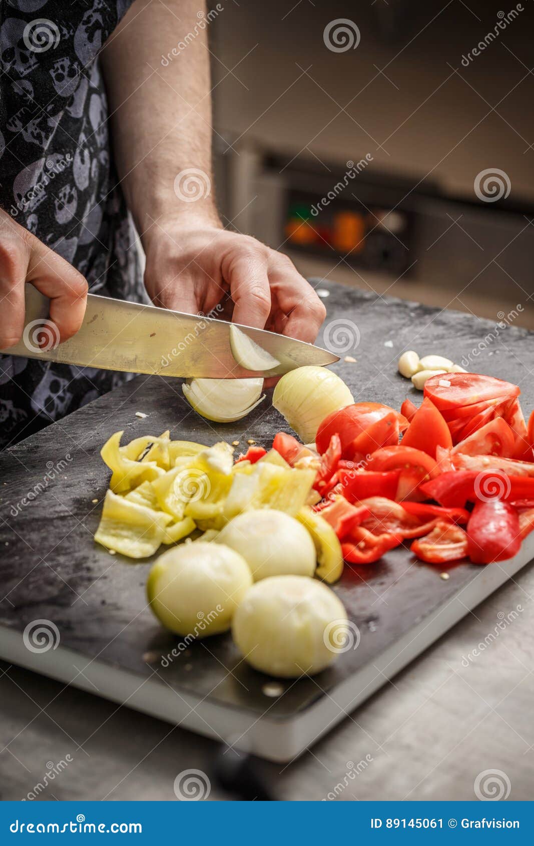 Chef is slicing vegetables stock image. Image of black - 89145061