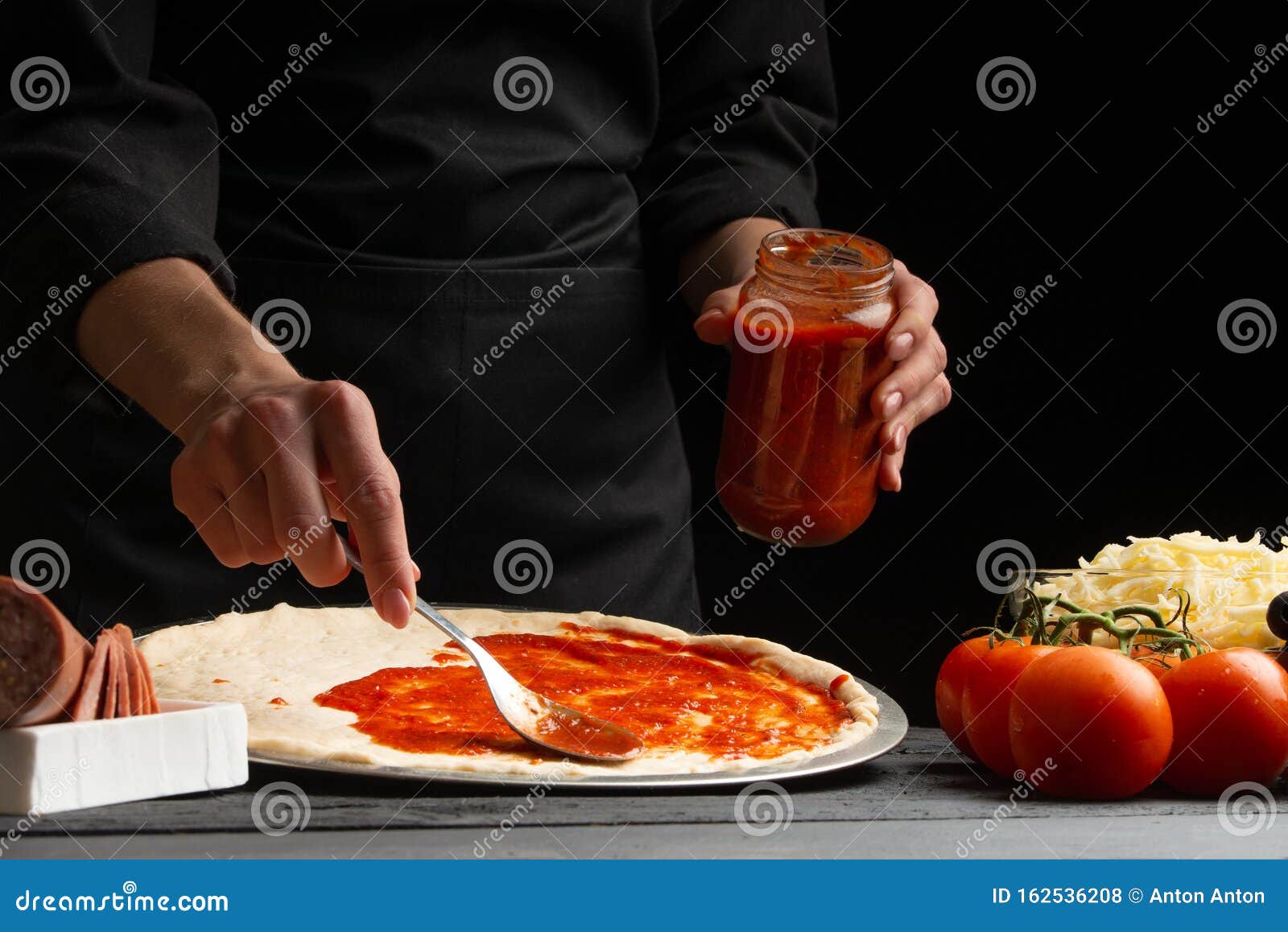 Chef Smears Italian Pizza Sauce, on Black Background Stock Photo ...