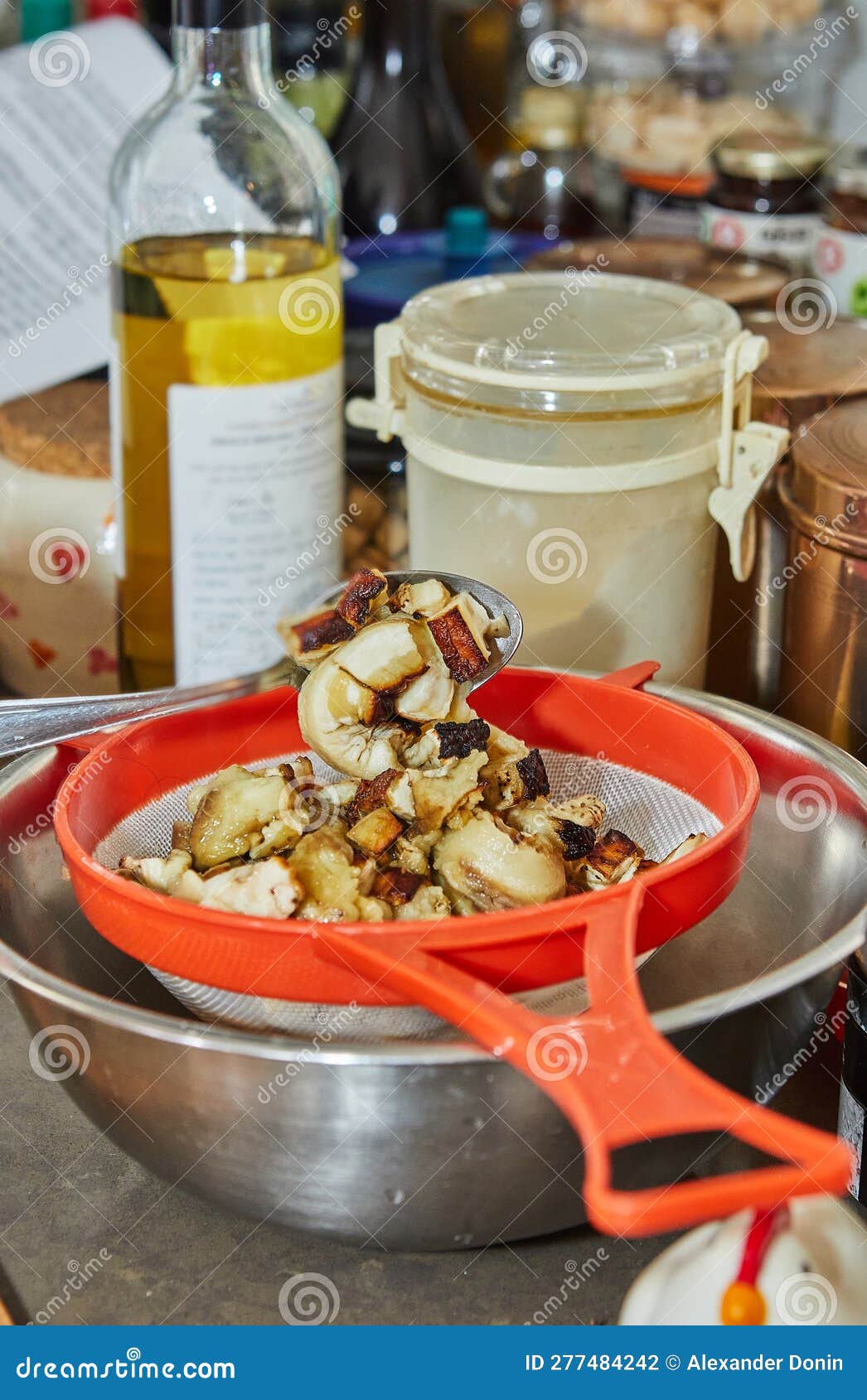 Chef Spoons the Pulp from an Oven-roasted Eggplant into Sieve Stock ...