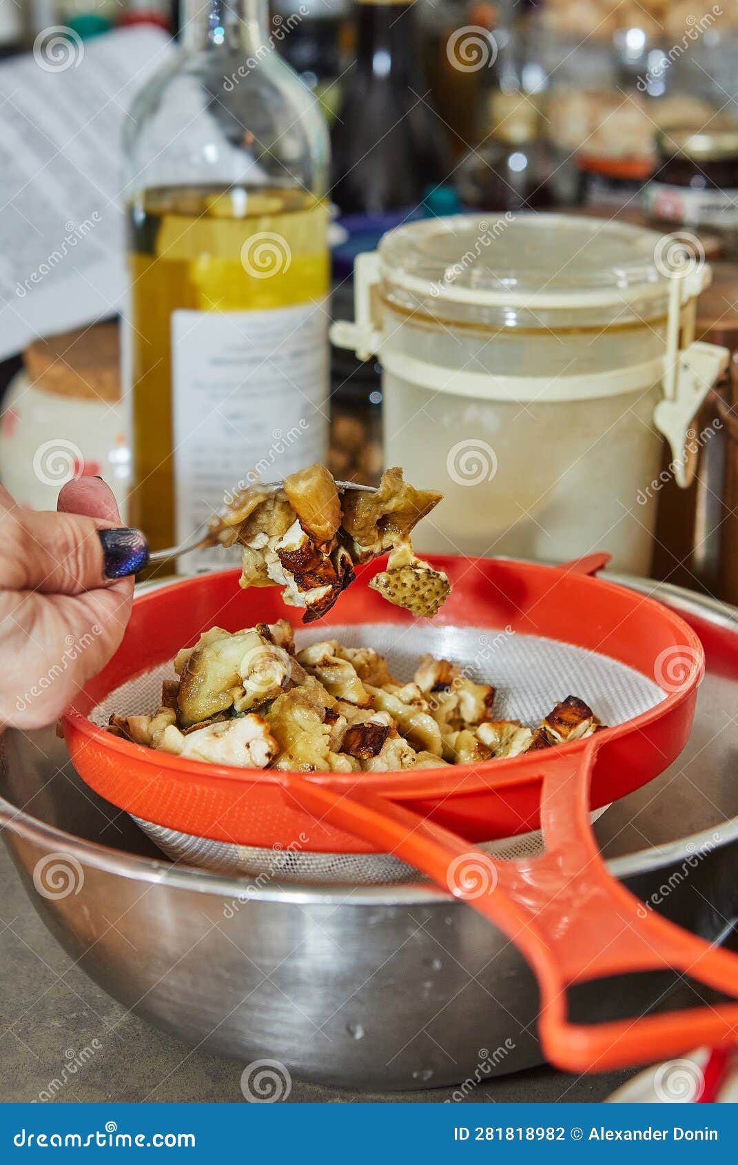 Chef Spoons the Pulp from an Oven-roasted Eggplant into Sieve Stock ...
