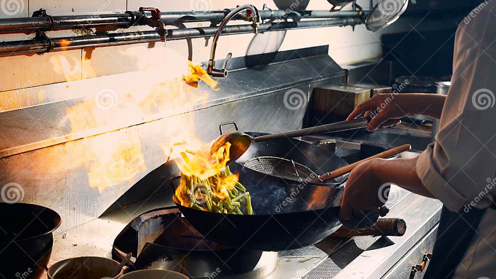 Chef stir fry cooking stock photo. Image of machine - 190128704