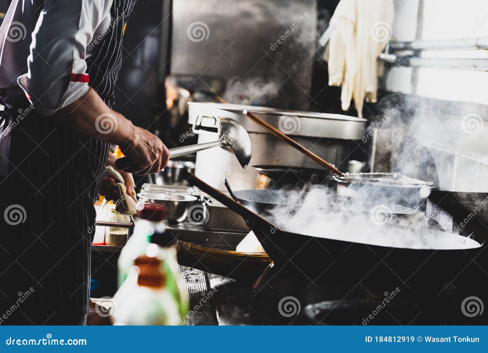 Chef stir fry in wok stock image. Image of busy, professional - 184812919
