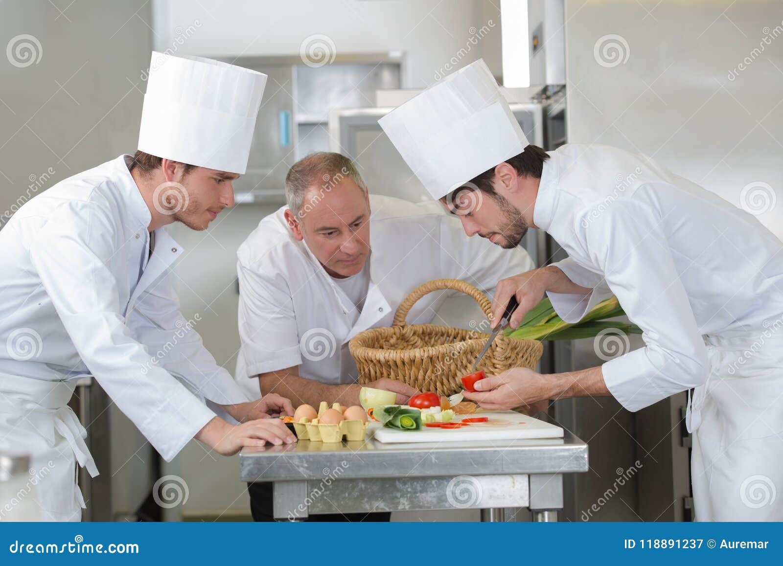 Chef Supervising Trainees Cooking Stock Image - Image of catering, cook ...