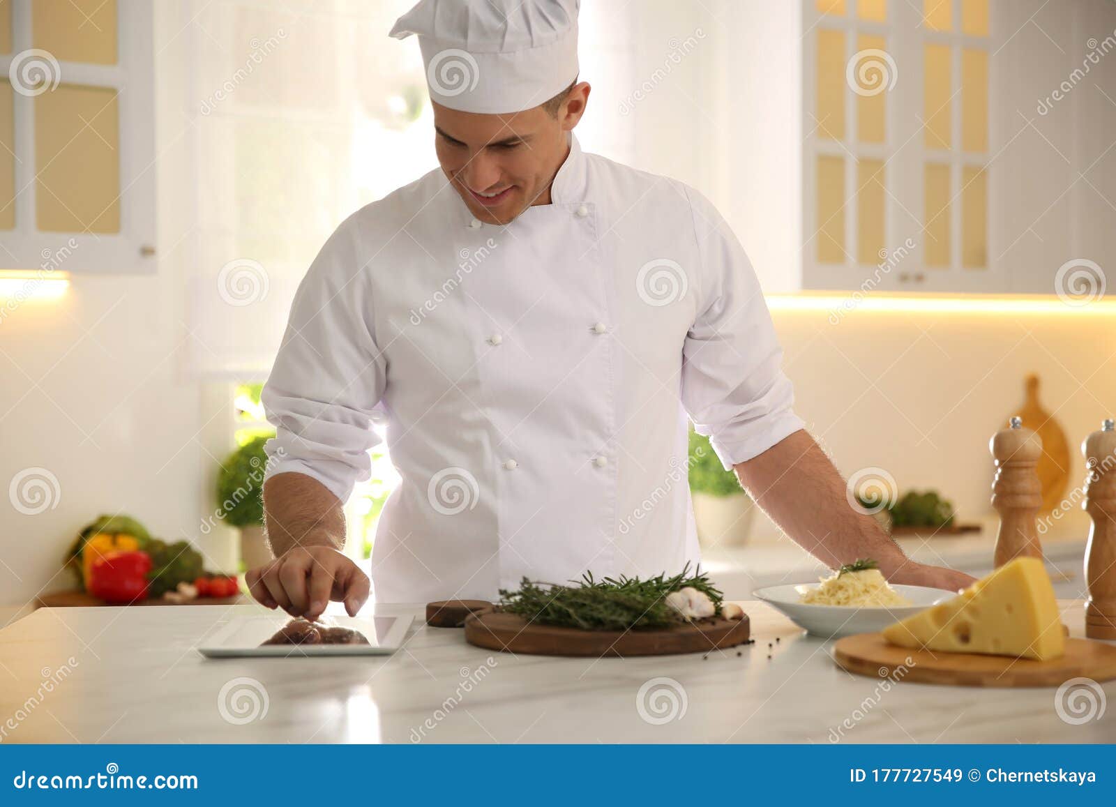 Chef with Tablet Cooking at Table Stock Image - Image of dinner, home ...