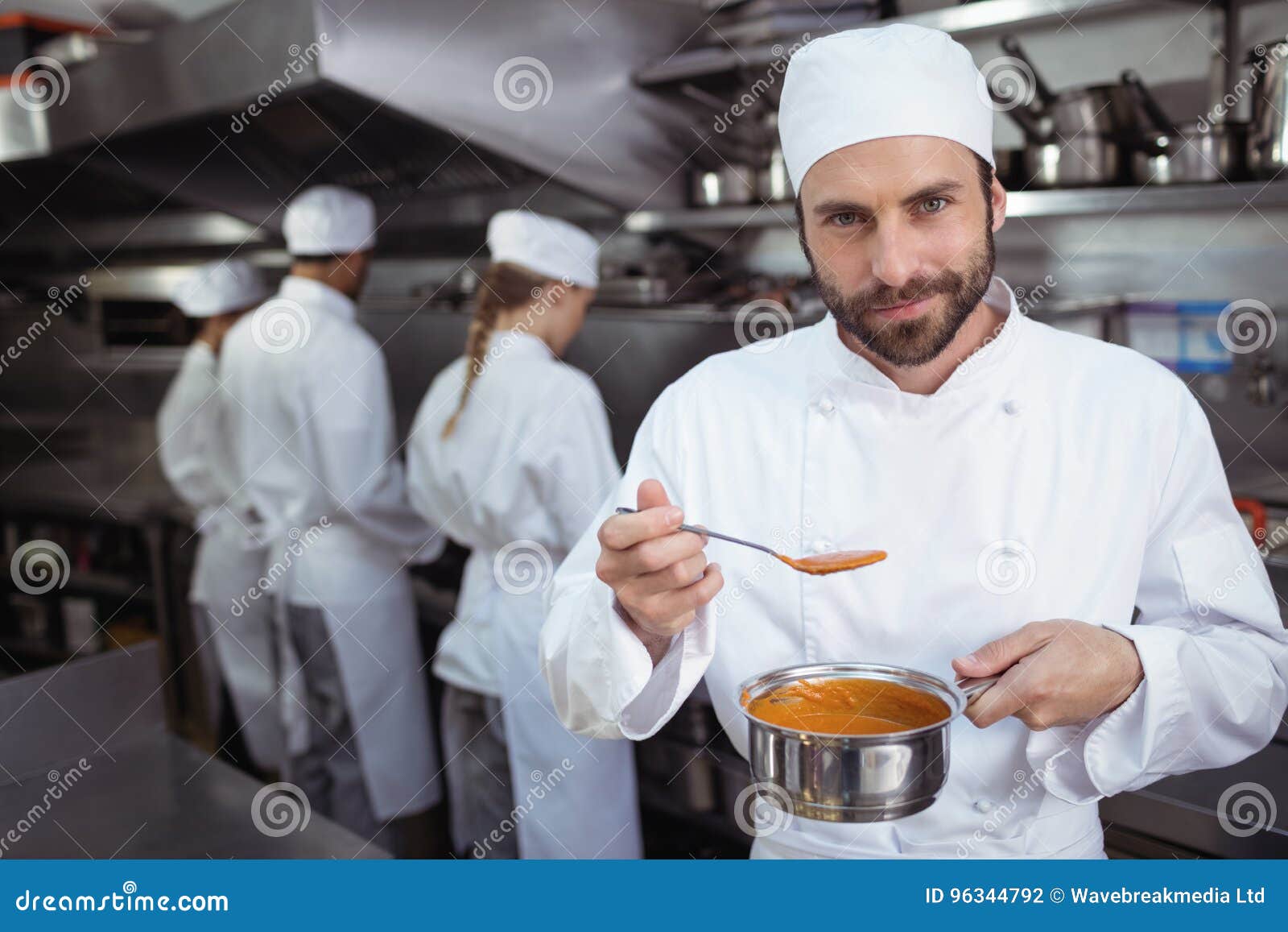 Chef Tasting Food from Spoon in Kitchen at Restaurant Stock Photo ...