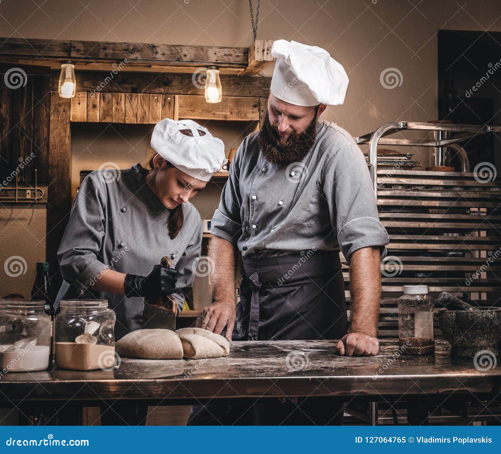 Chef Teaching His Assistant To Bake the Bread in a Bakery. Stock Image ...