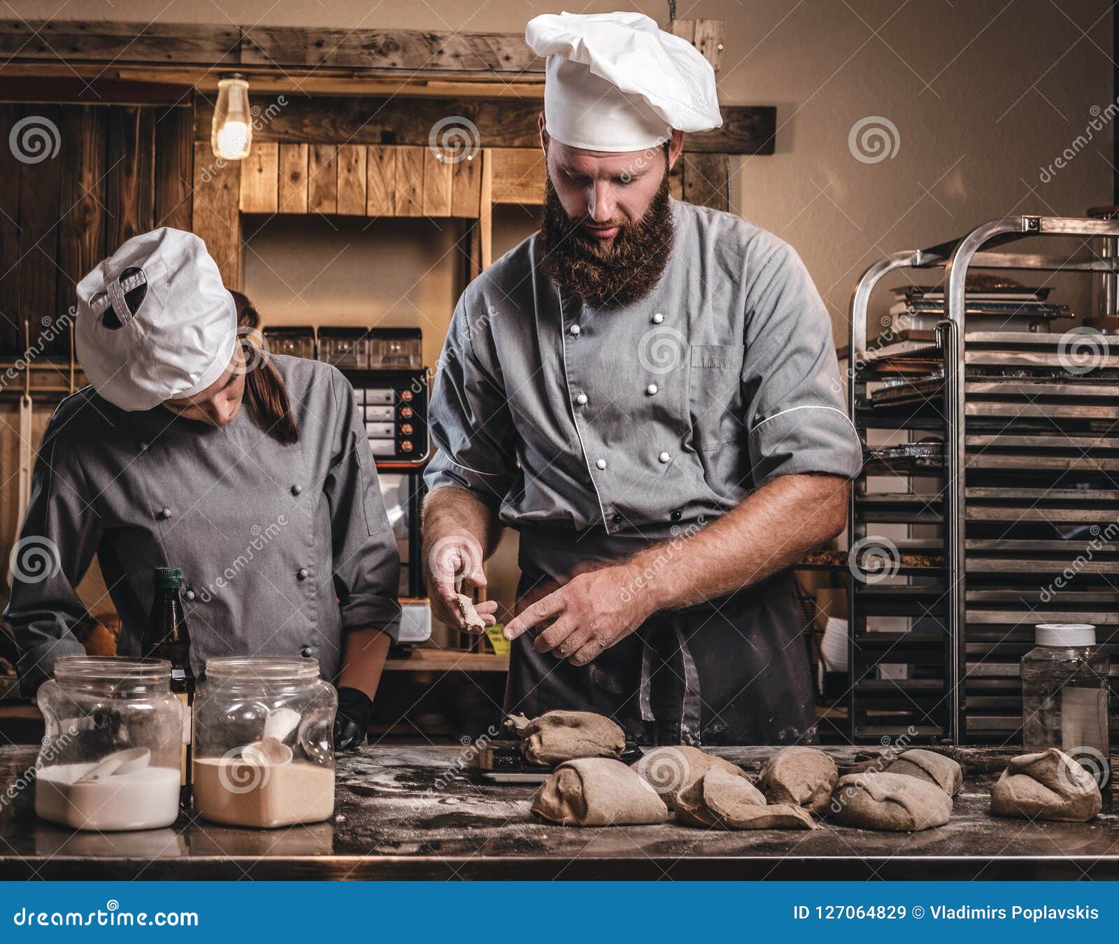 Chef Teaching His Assistant To Bake the Bread in a Bakery. Stock Image ...