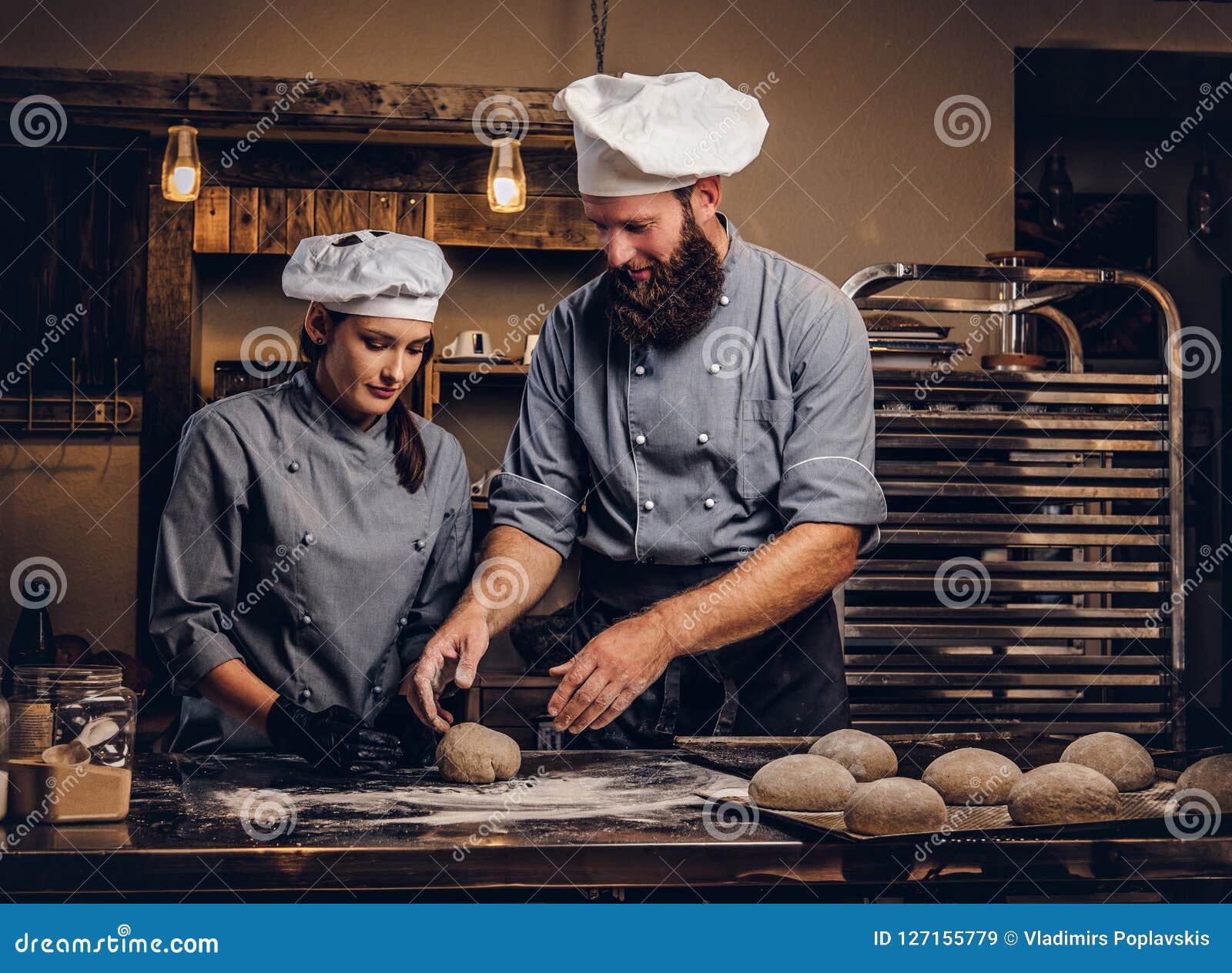 Chef Teaching His Assistant To Bake the Bread in a Bakery. Stock Image ...