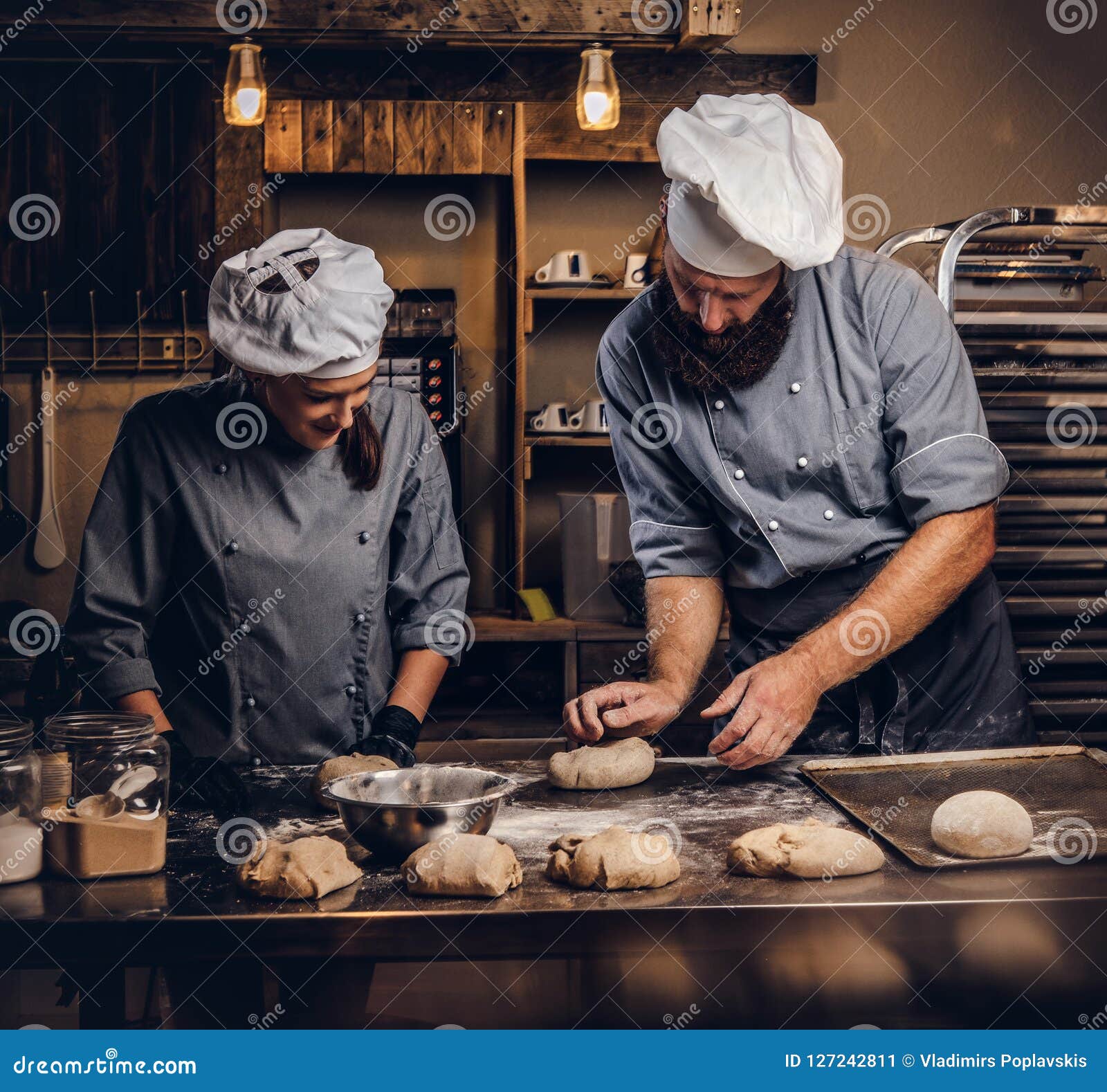 Chef Teaching His Assistant To Bake the Bread in a Bakery. Stock Image ...