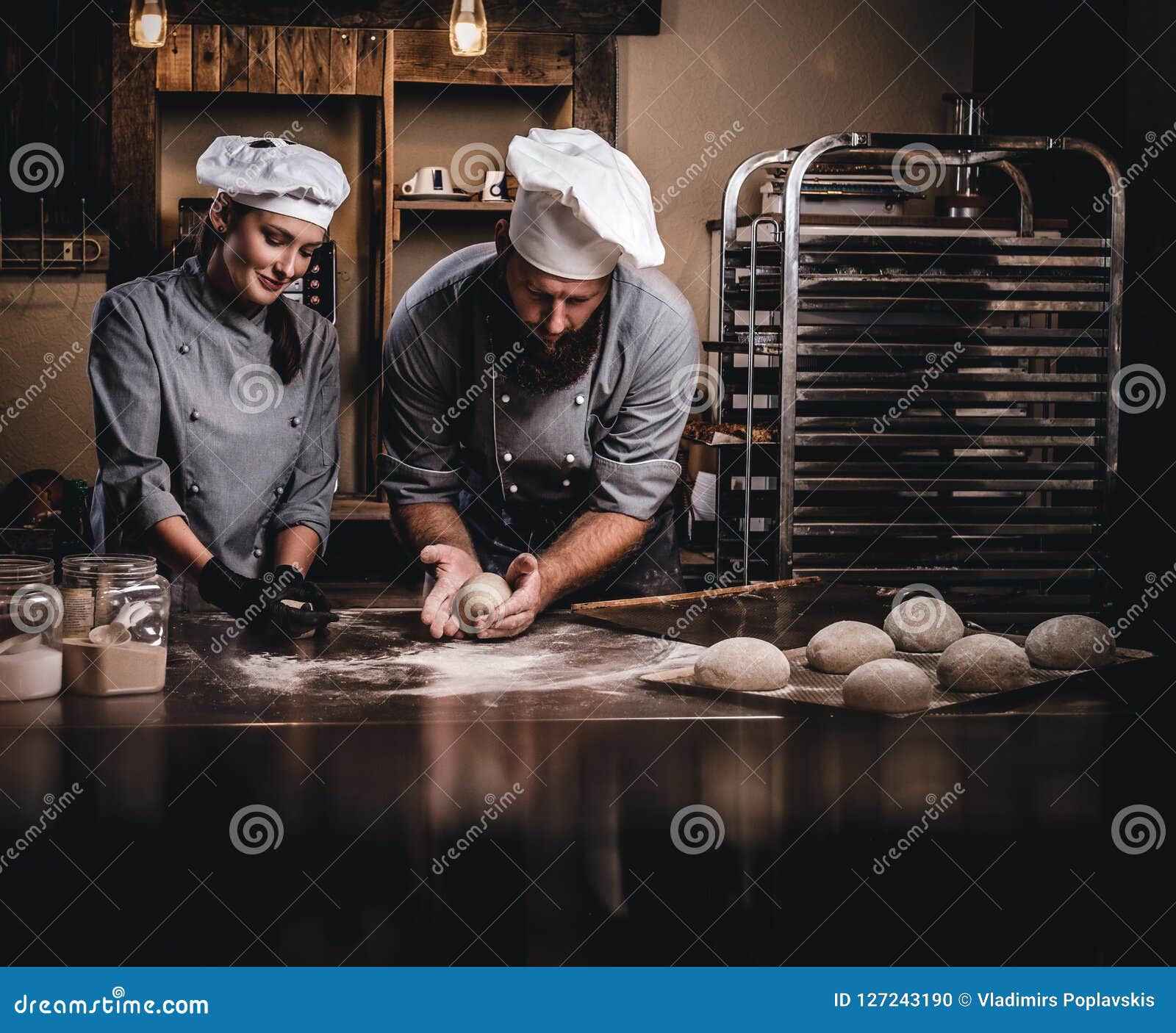Chef Teaching His Assistant To Bake the Bread in a Bakery. Stock Photo ...