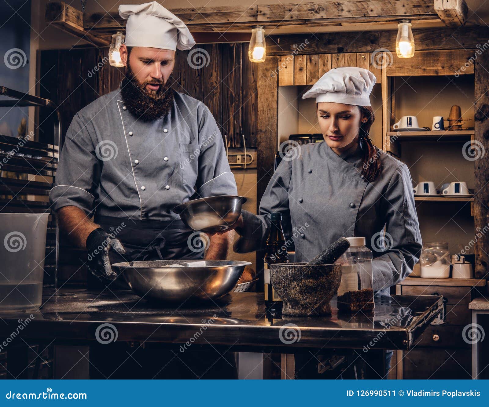 Chef Teaching His Assistant To Bake the Bread in the Bakery. Stock ...