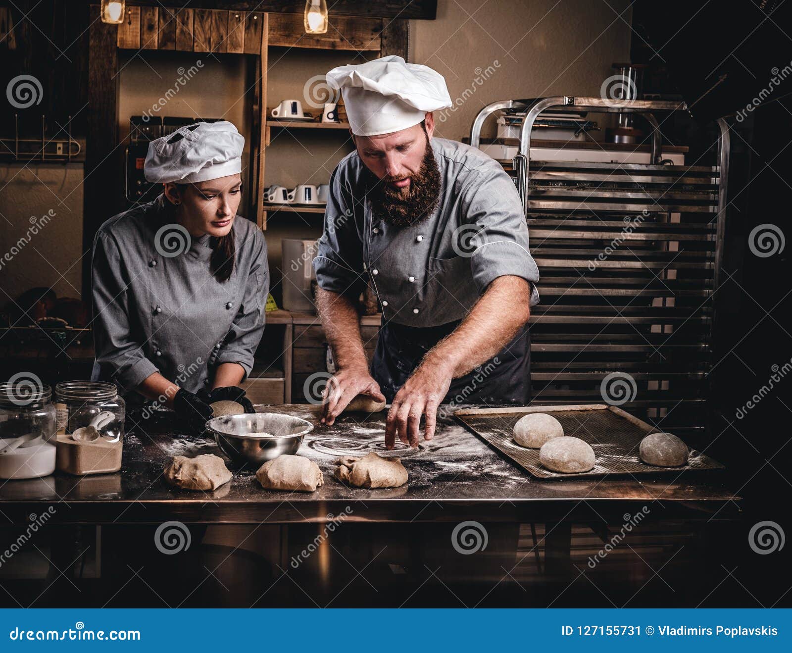 Chef Teaching His Assistant To Bake the Bread in a Bakery. Stock Image ...