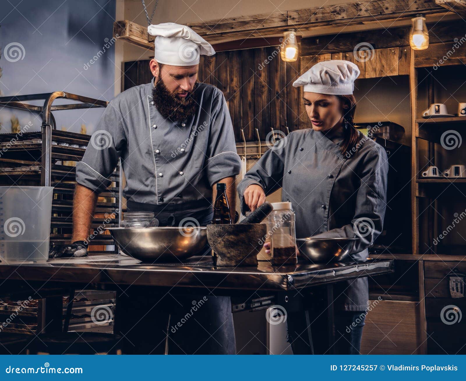 Chef Teaching His Assistant To Bake the Bread in the Bakery. Stock ...
