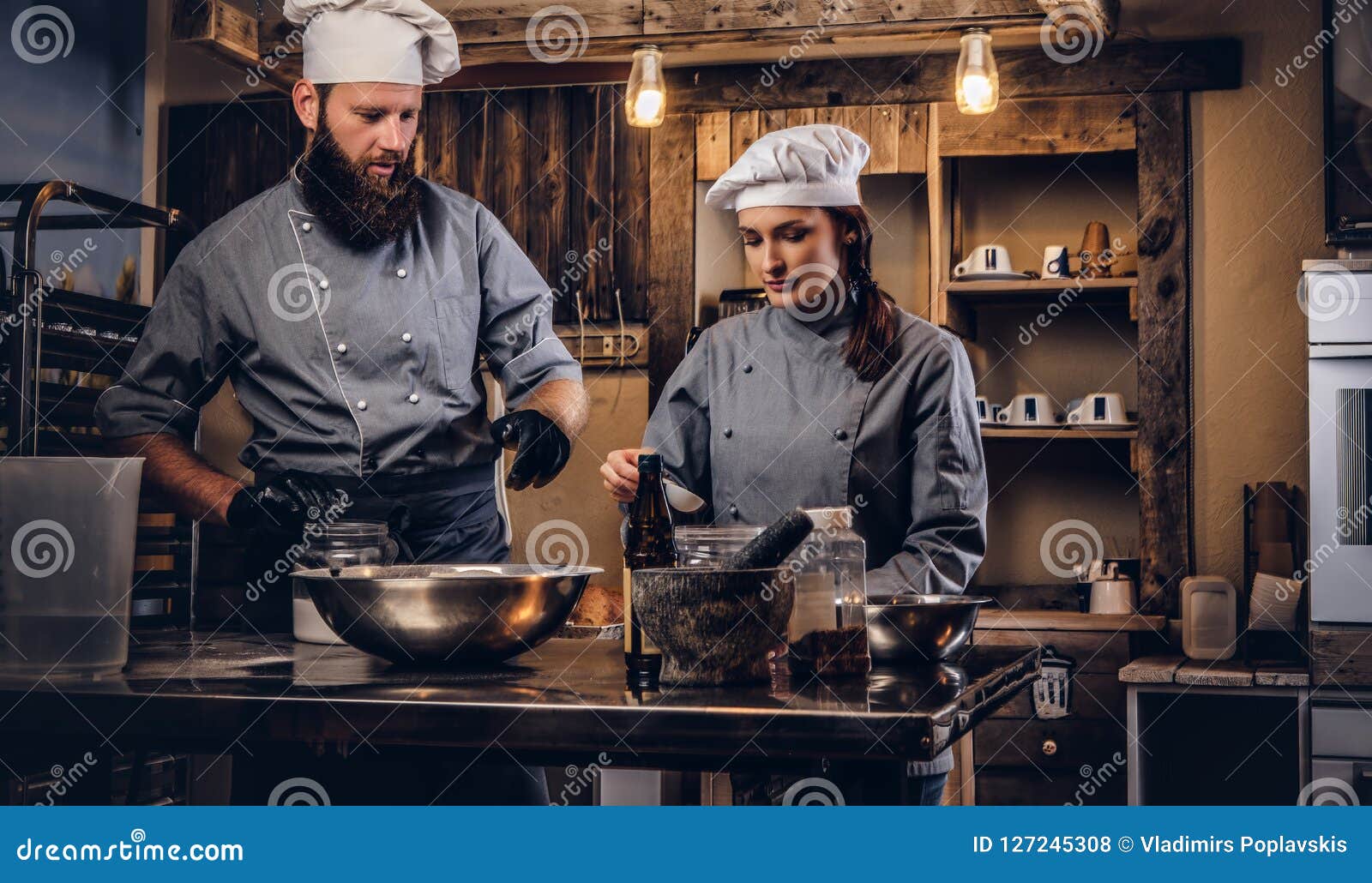 Chef Teaching His Assistant To Bake the Bread in the Bakery. Stock ...