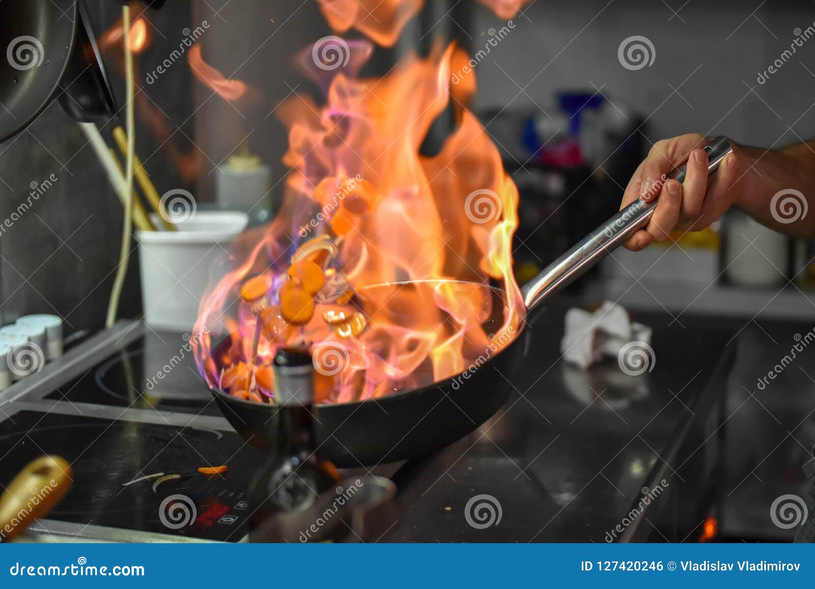 Chef Tossing Vegetables Flambe in a Pan Over the Burner Stock Photo ...