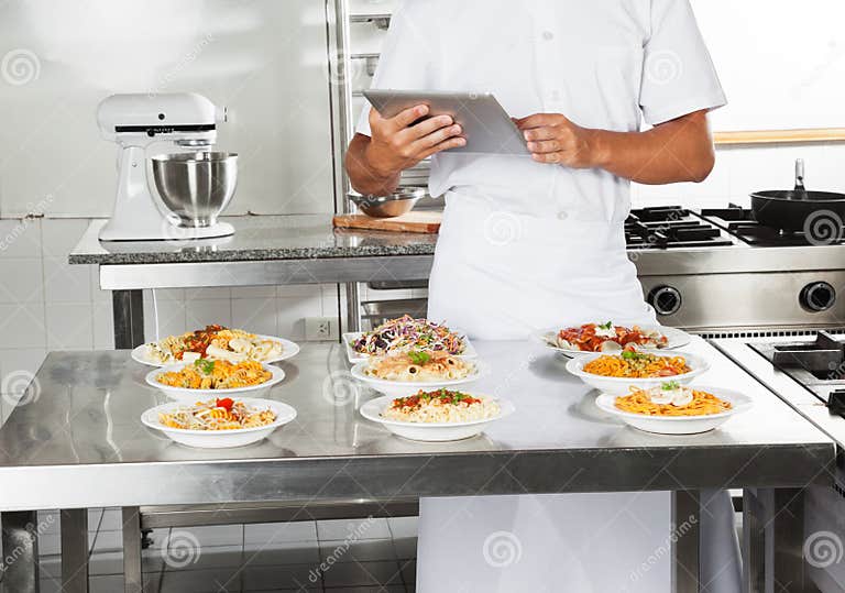 Chef Using Digital Computer in Kitchen Stock Image - Image of digital ...
