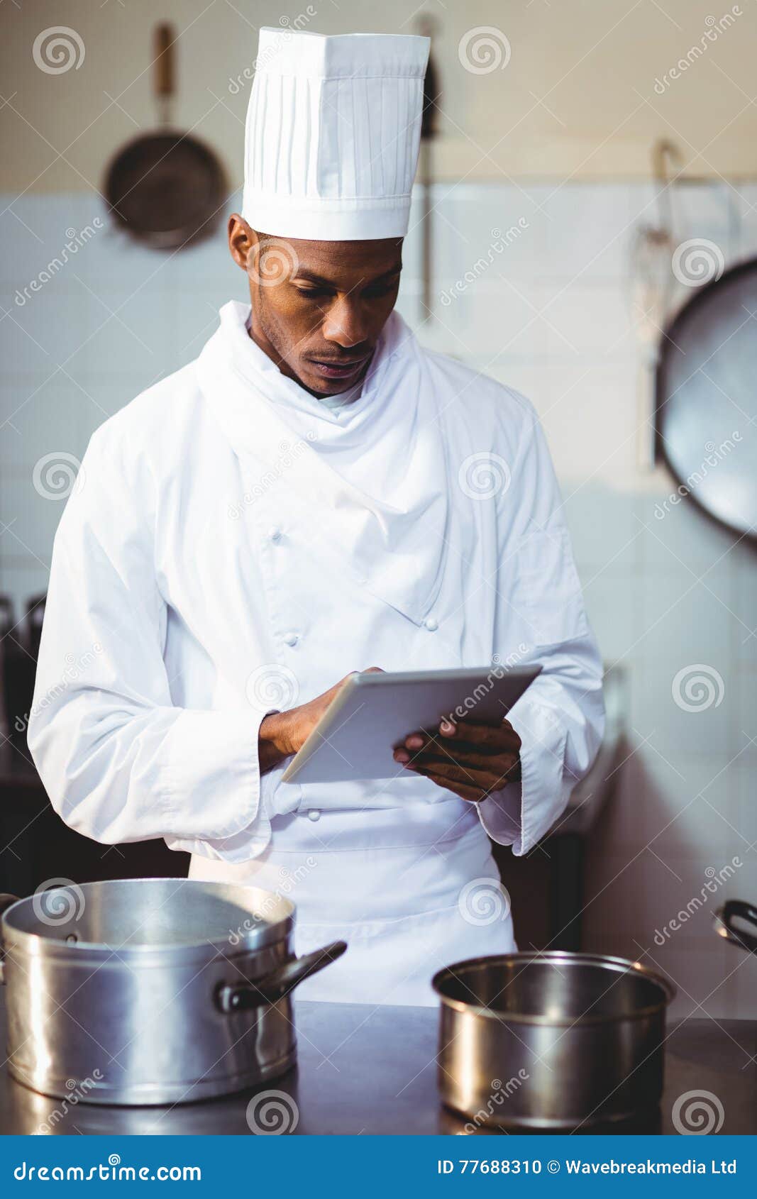 Chef using digital tablet stock photo. Image of expertise - 77688310