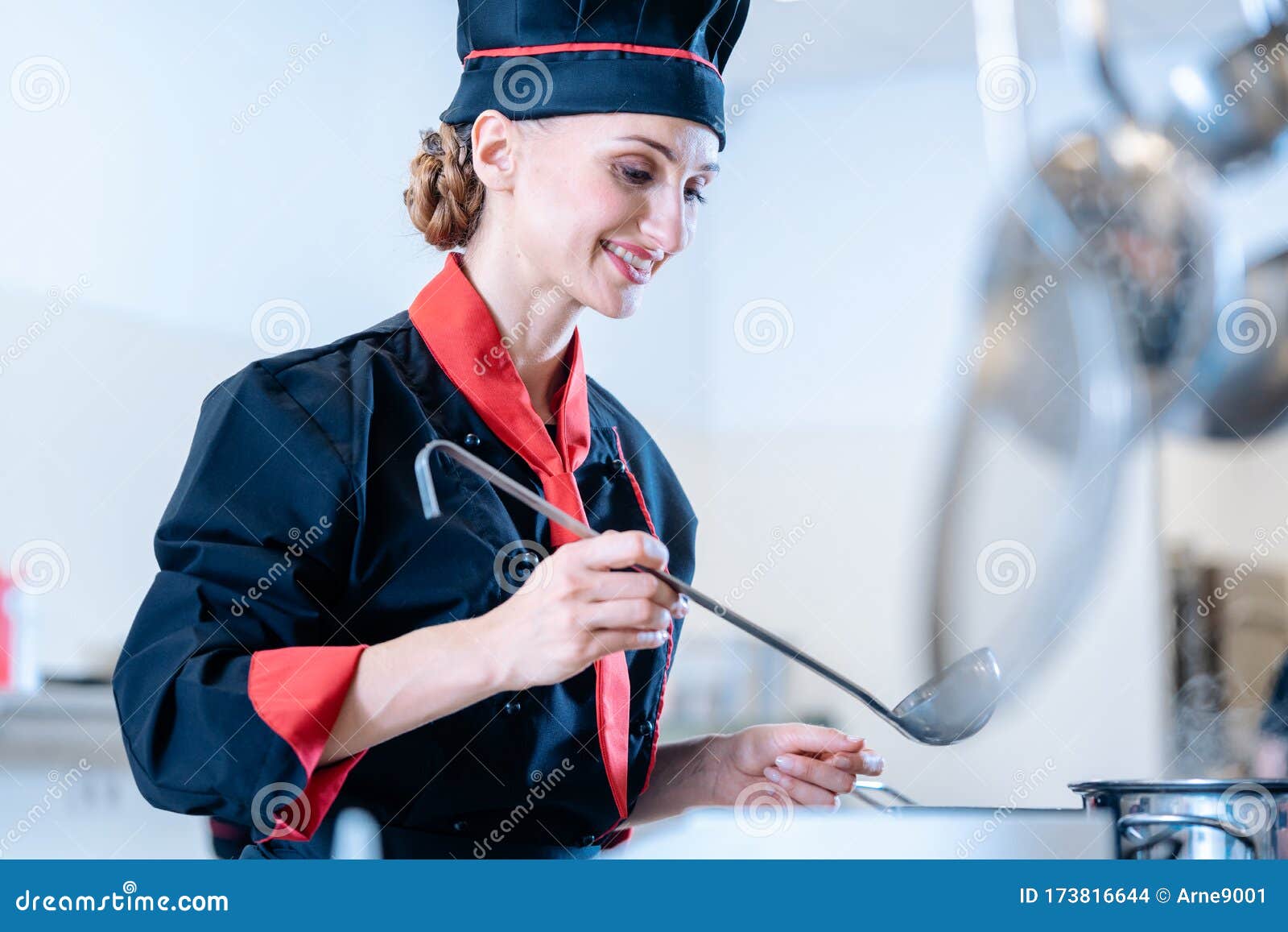 Chef using a metal ladle stock photo. Image of preparation - 173816644
