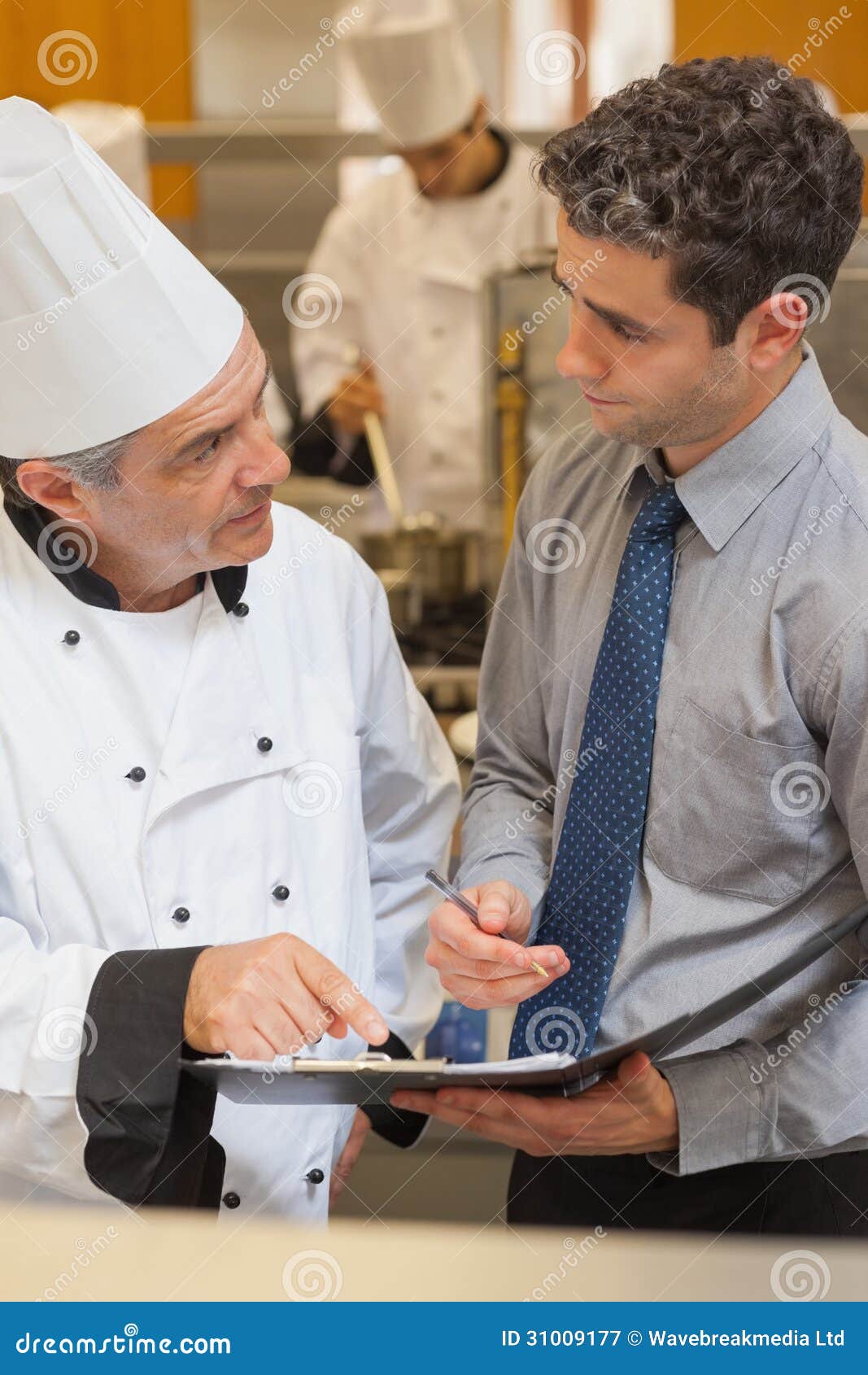 Chef and Waiter Having a Discussion Stock Image - Image of caucasian ...