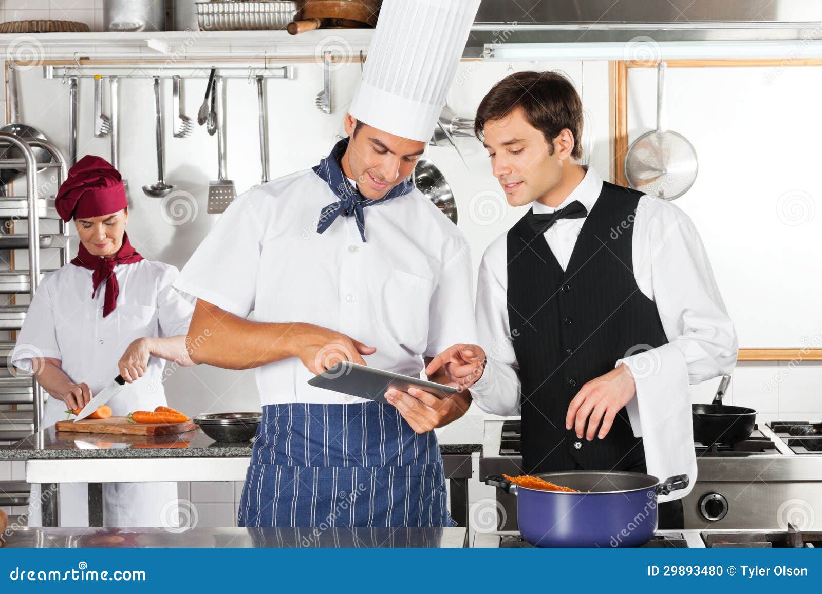 Waiter and Chef Using Digital Tablet in Kitchen Stock Photo - Image of ...