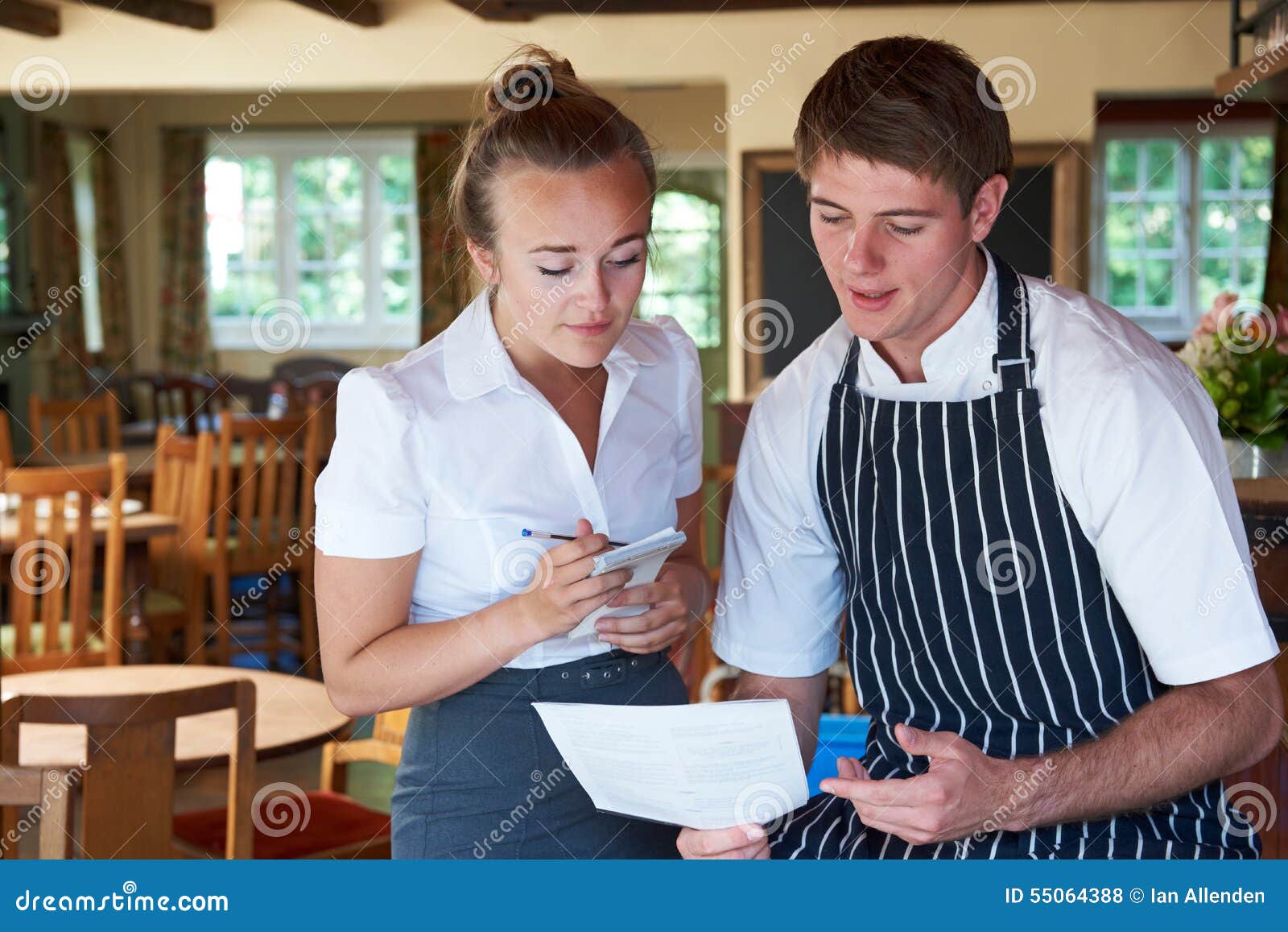 Chef and Waitress Discussing Menu in Restaurant Stock Photo - Image of ...