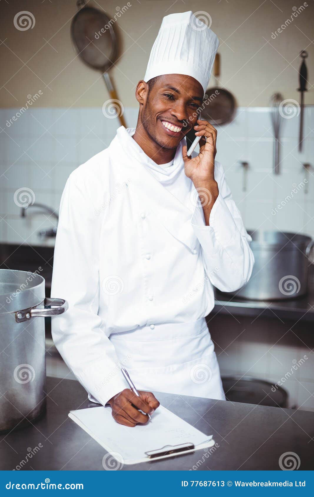 Chef Writing on Clipboard while Talking on Phone Stock Image - Image of ...