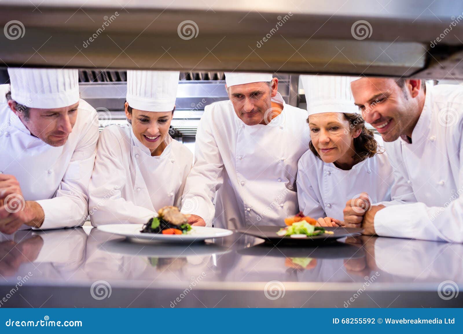 Chefs Looking at the Dish Prepared by Them Stock Photo - Image of ...