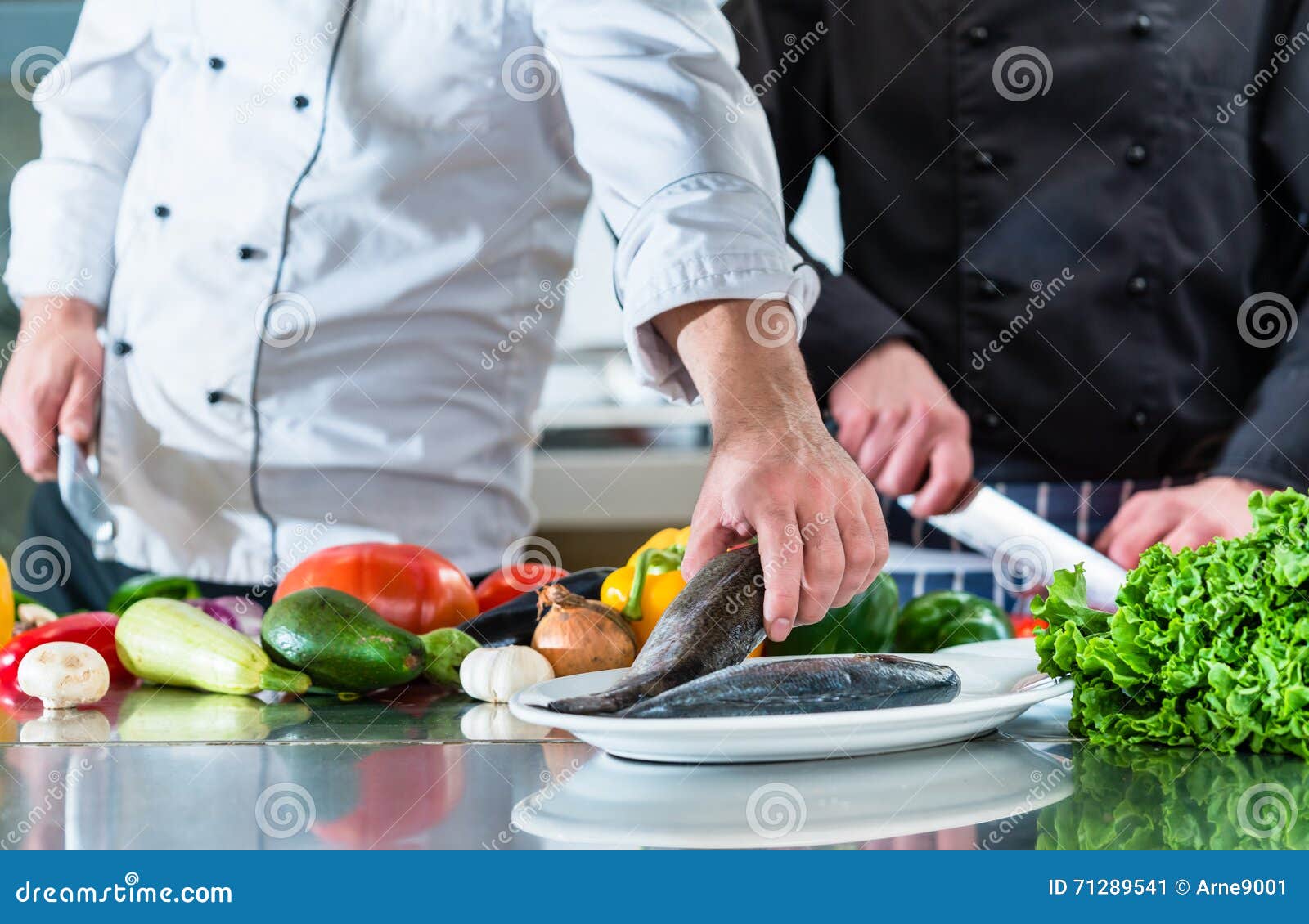 Chefs Preparing Food in Teamwork at Restaurant Kitchen Stock Image ...