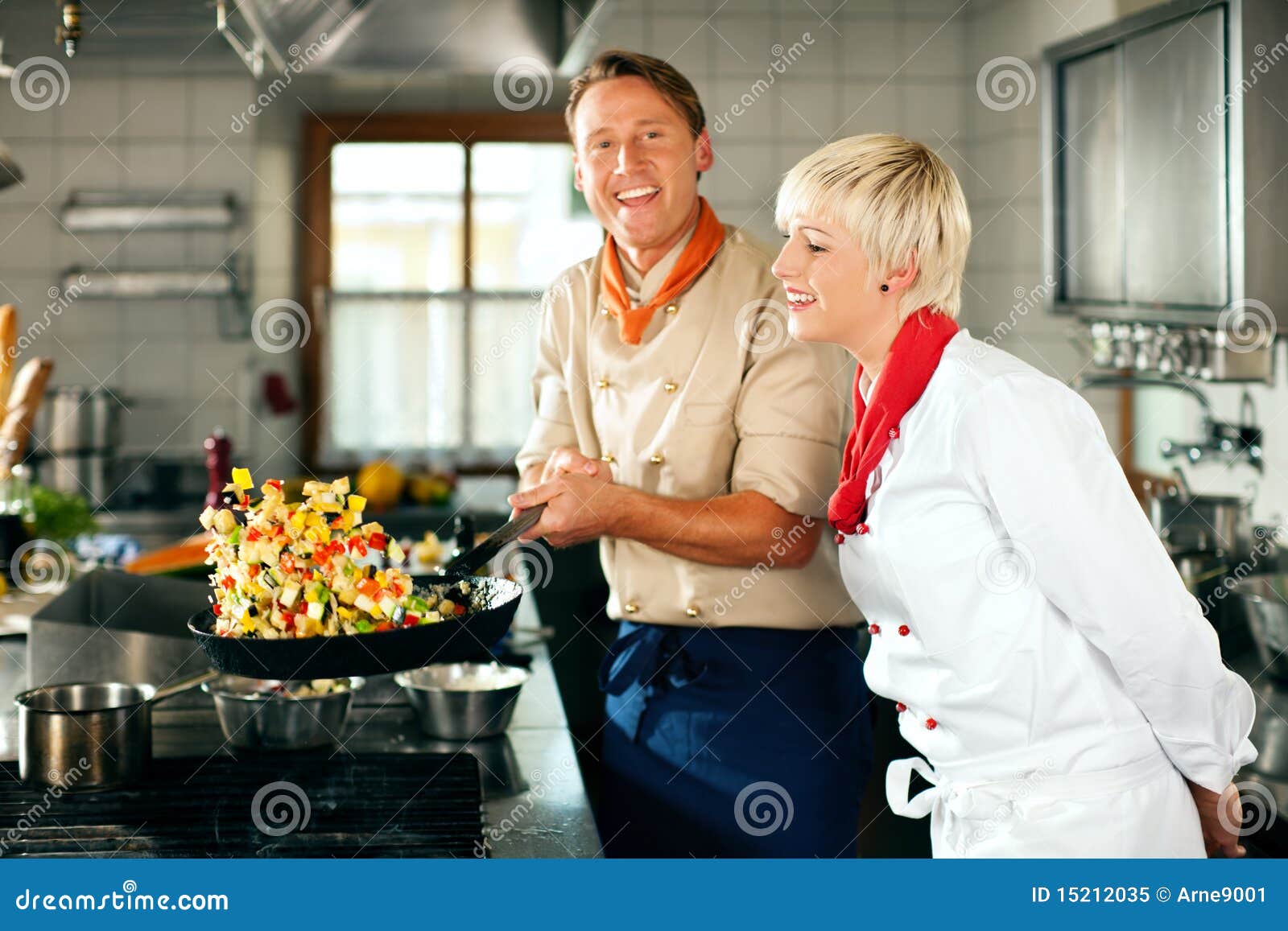 Chefs in a Restaurant or Hotel Kitchen Cooking Stock Image - Image of ...