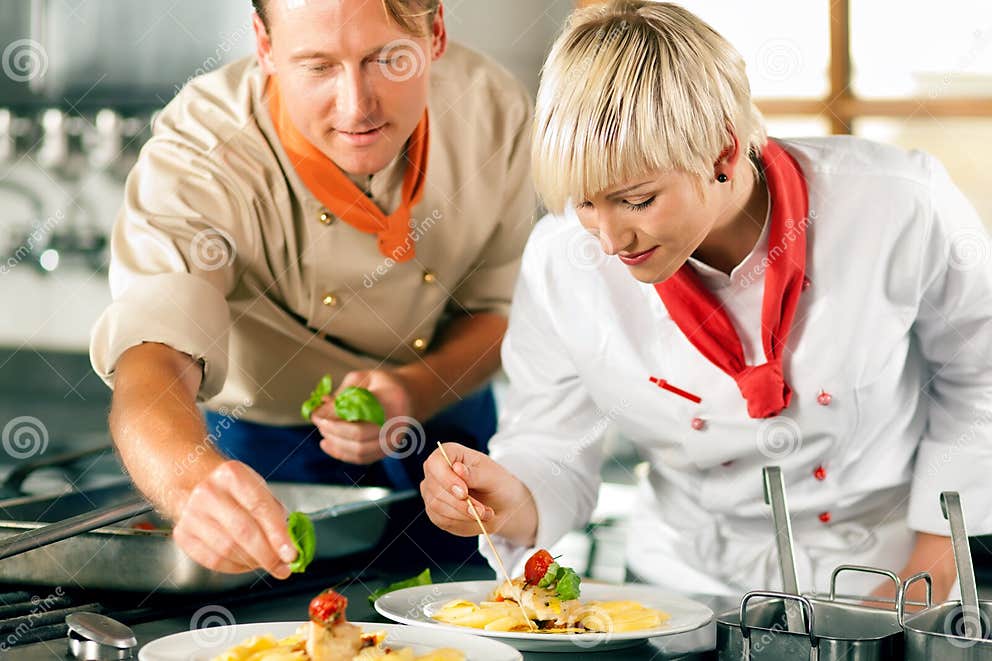 Chefs in a Restaurant or Hotel Kitchen Cooking Stock Image - Image of ...
