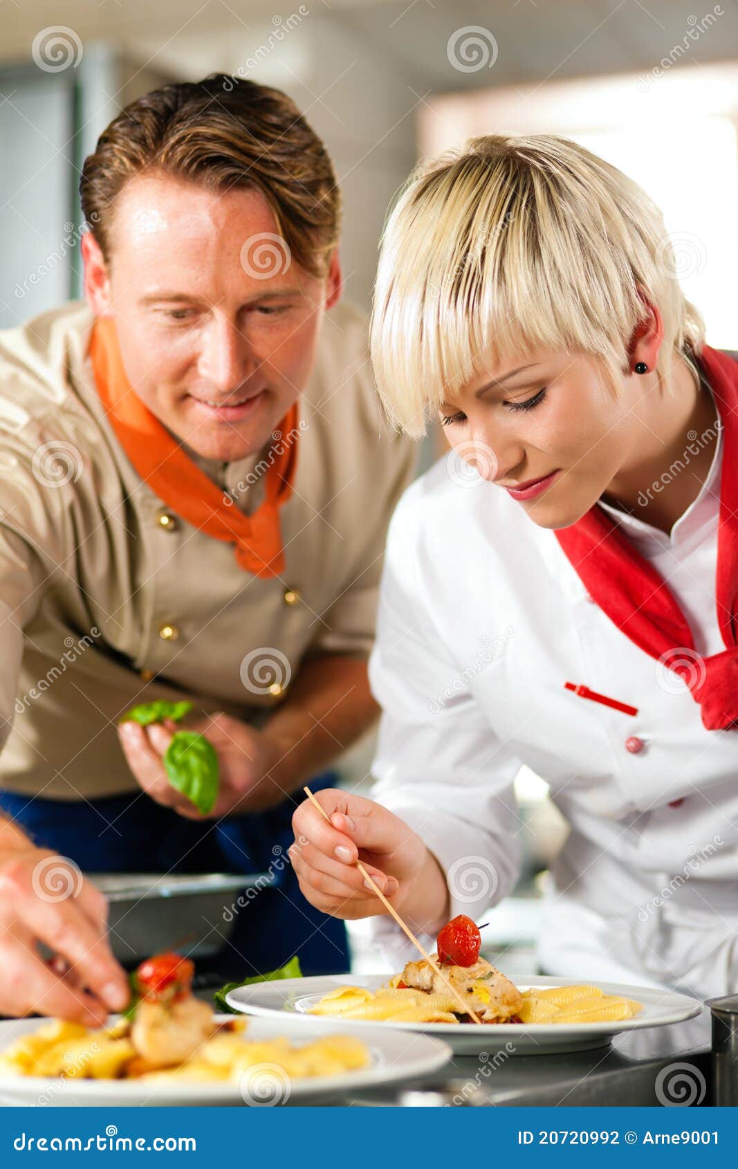 Chefs in a Restaurant or Hotel Kitchen Cooking Stock Photo - Image of ...